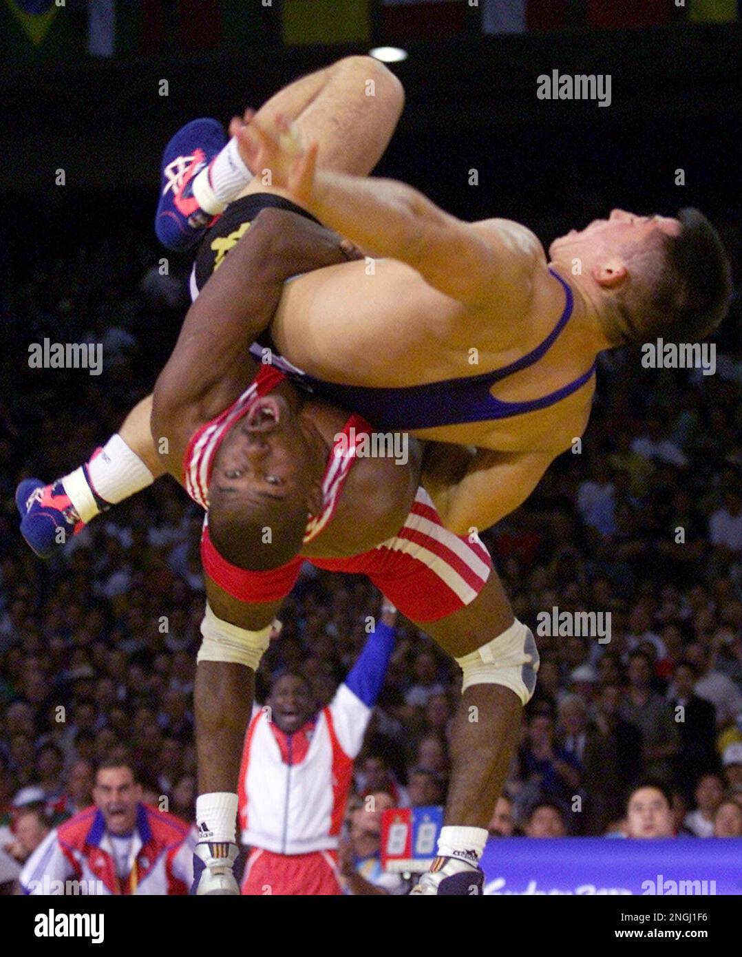 Cuba's Filiberto Azcuy throws Japan's Katsuhiko Nagata back on the mat to win their final bout ...