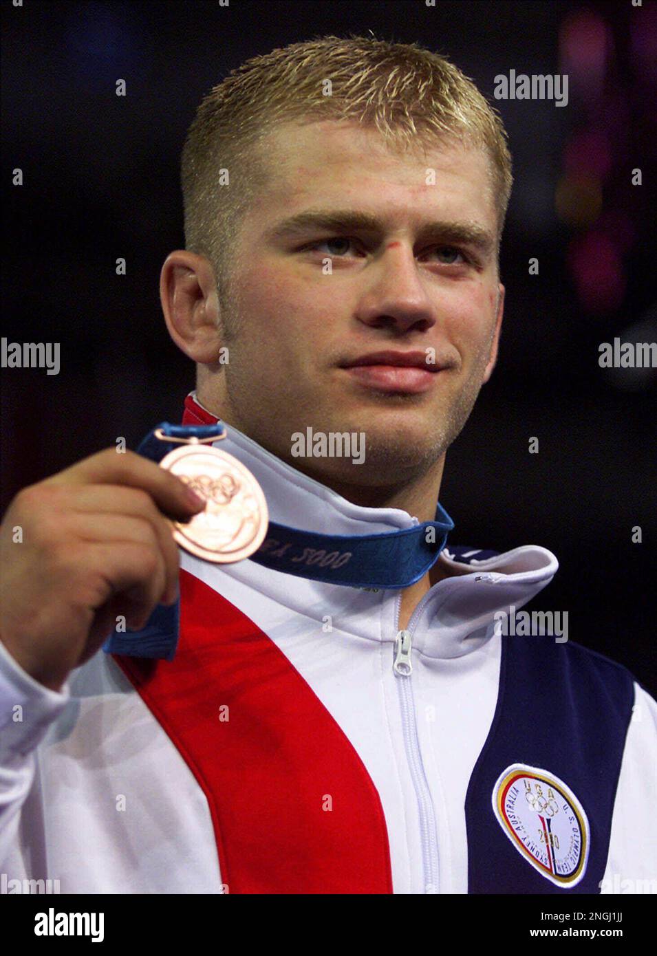 Garrett Lowney of the United States shows off the bronze medal he won ...