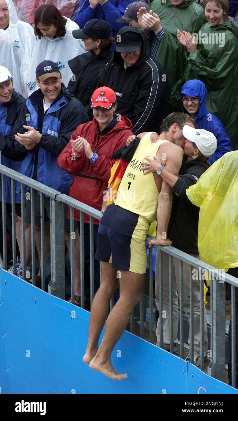 Germany's Joerg Ahmann jumps up into the grandstand to kiss his wife ...