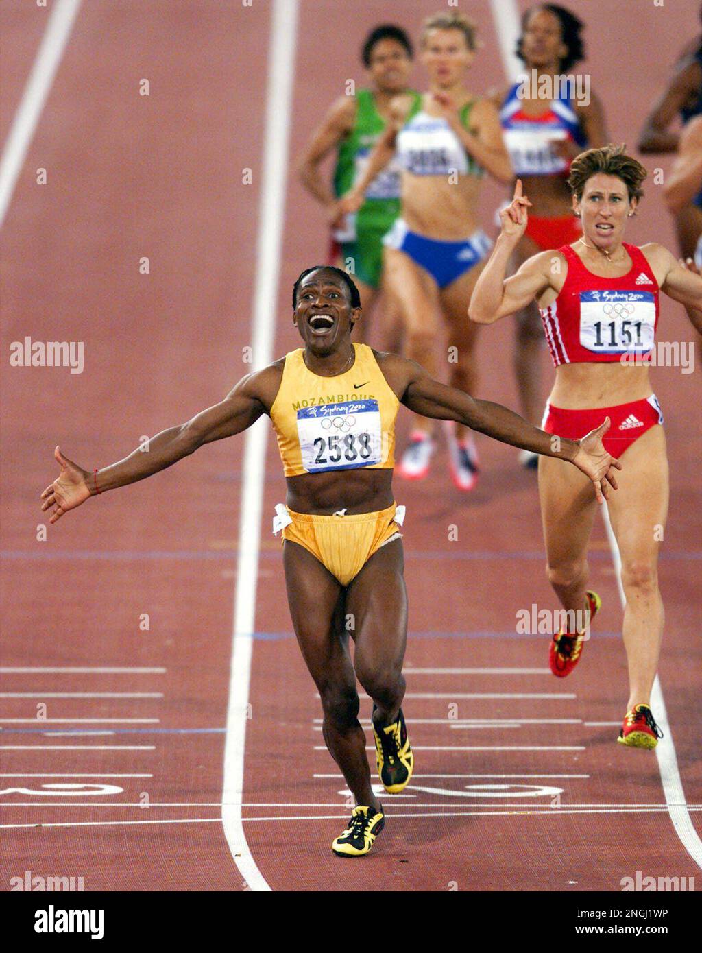 Maria Mutola of Mozambique, celebrates as she crosses the finish line ...