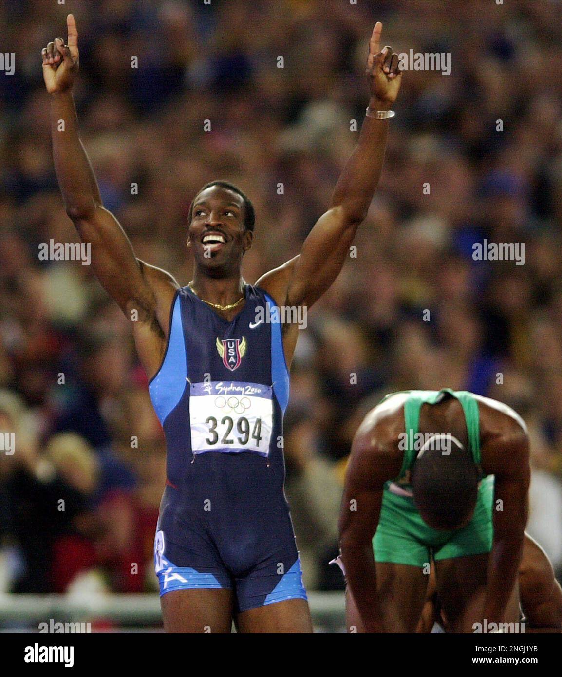 U.S. sprinter Michael Johnson celebrates winning the gold medal in the ...