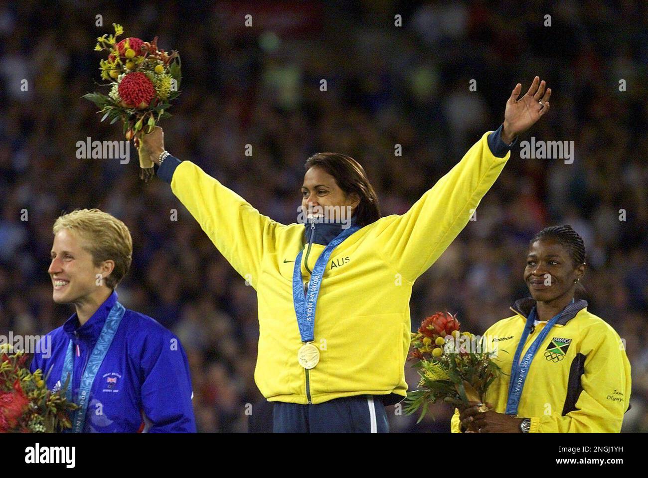 Australia's Cathy Freeman stands center with her gold medal for the ...