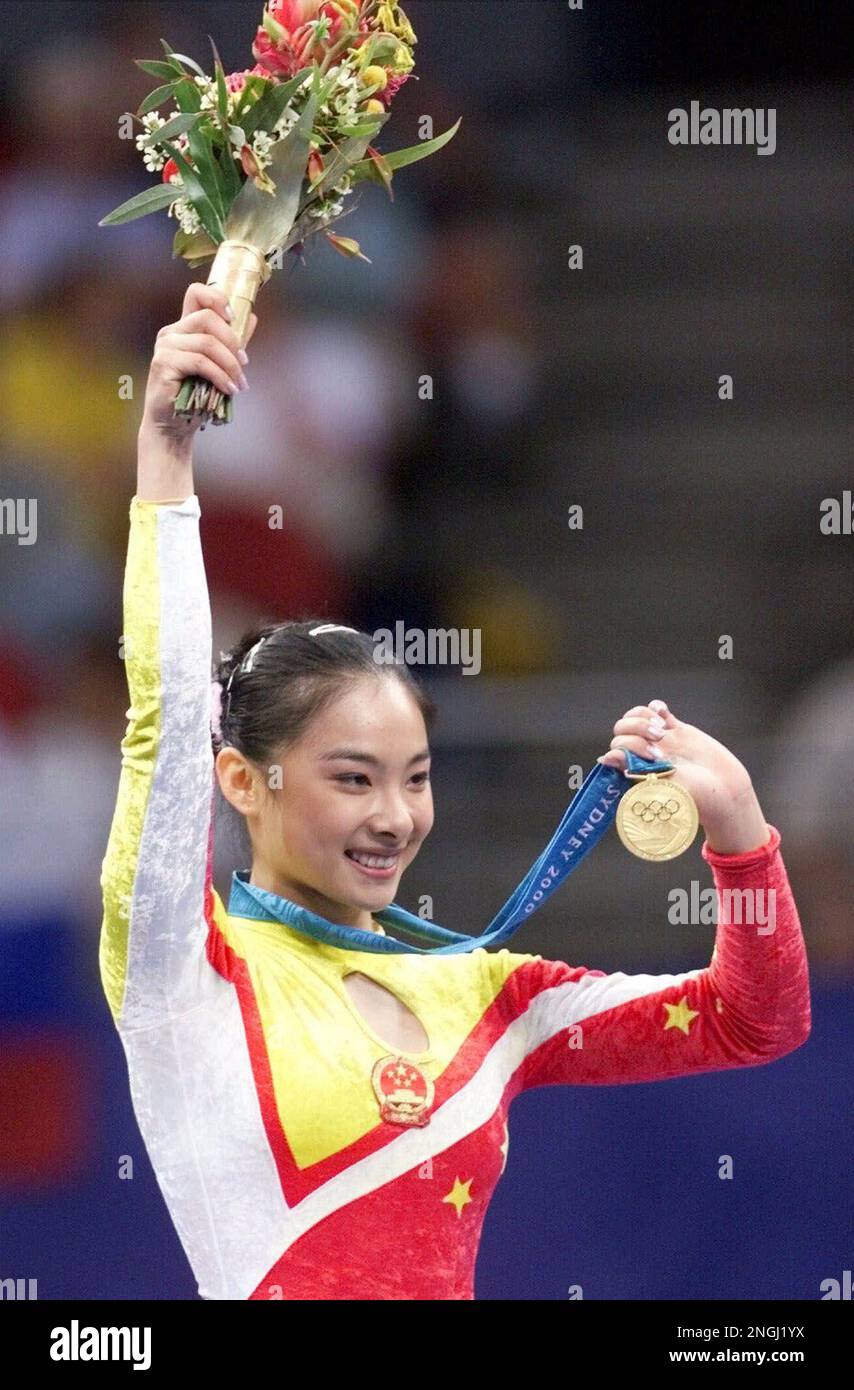 Liu Xuan of China shows her gold medal for the balance beam during the ...