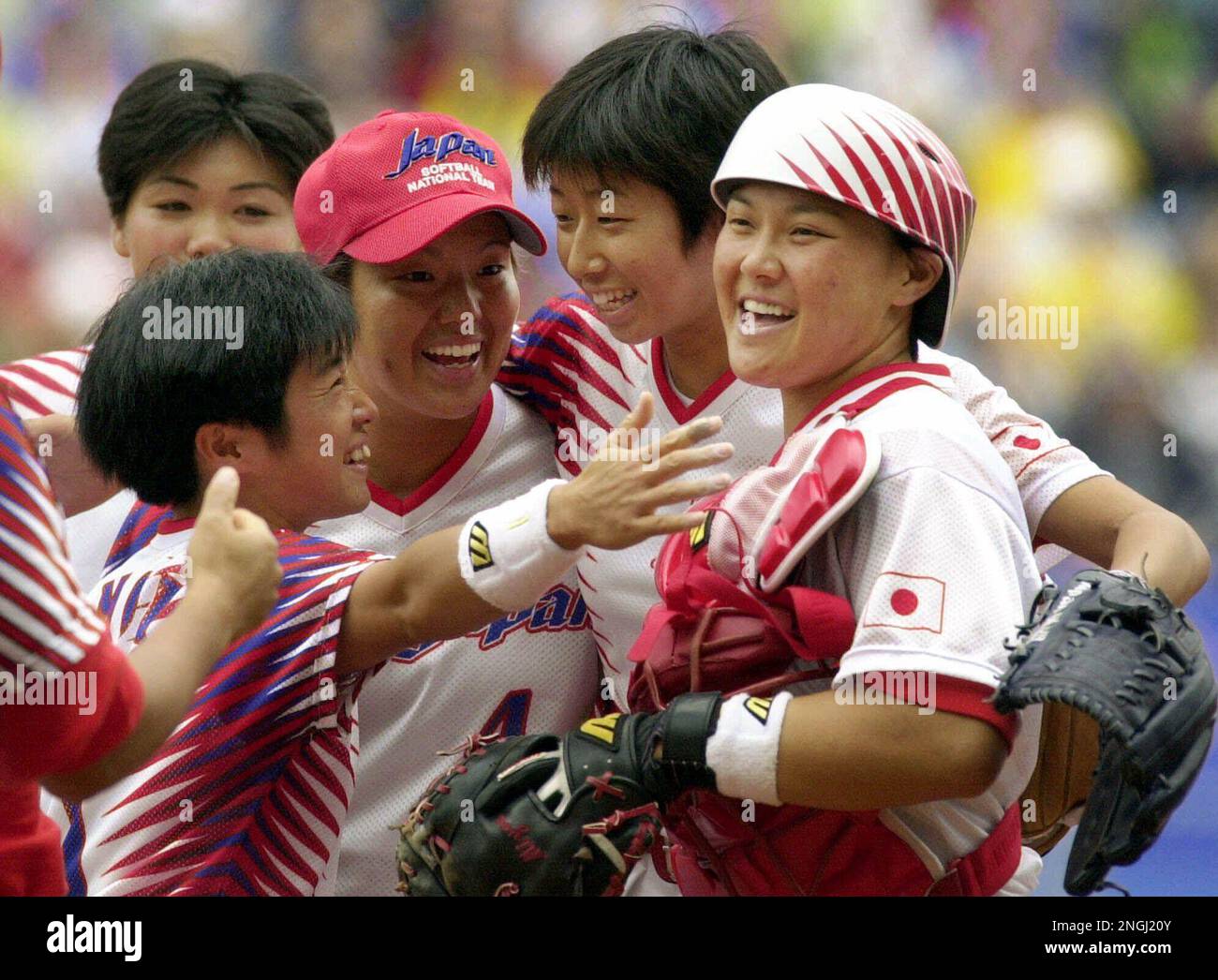 Japanese teammates rush forward to greet catcher Miyo Yamada, right ...