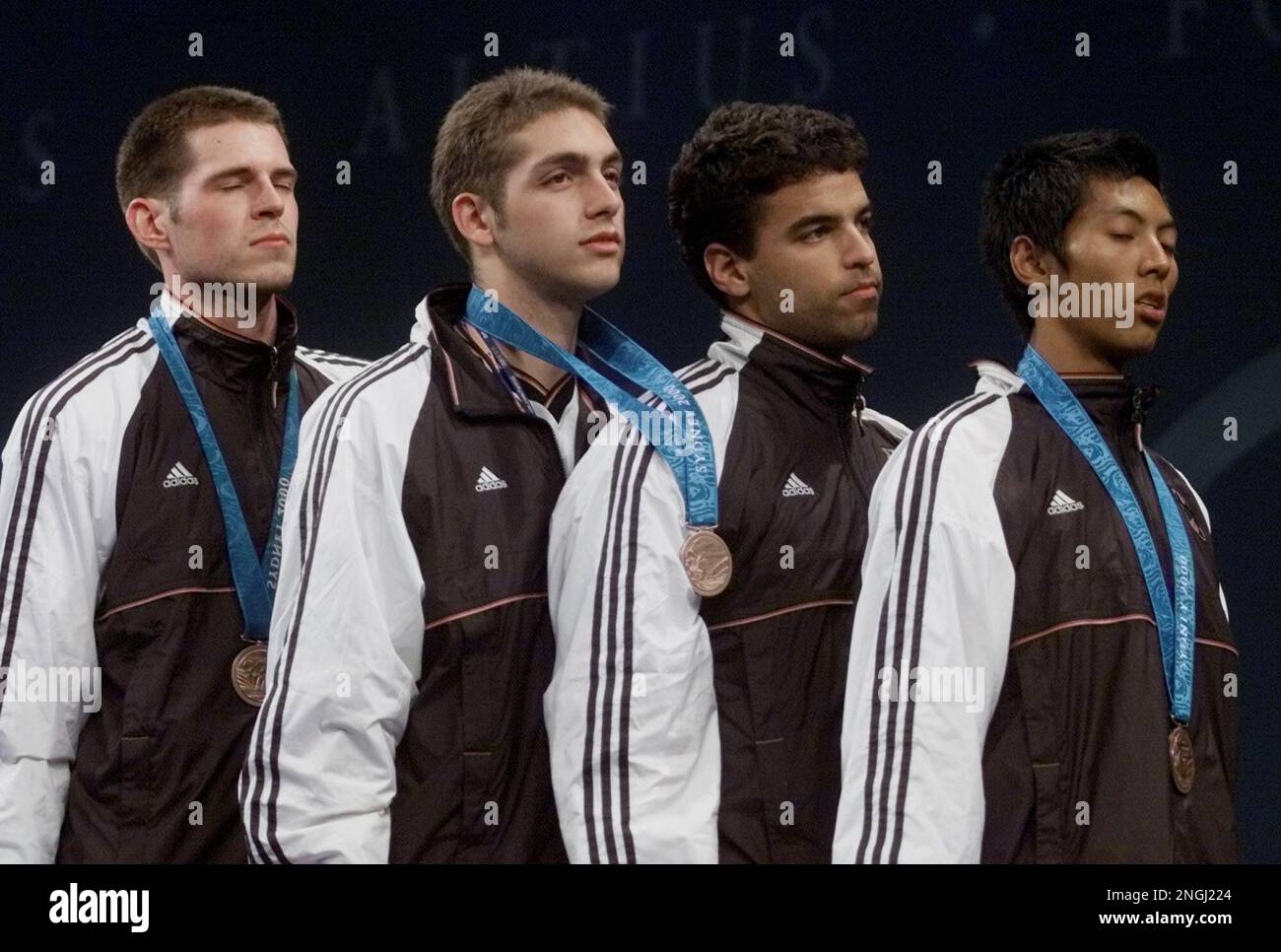Members of the German men's team listen to their national anthem after ...