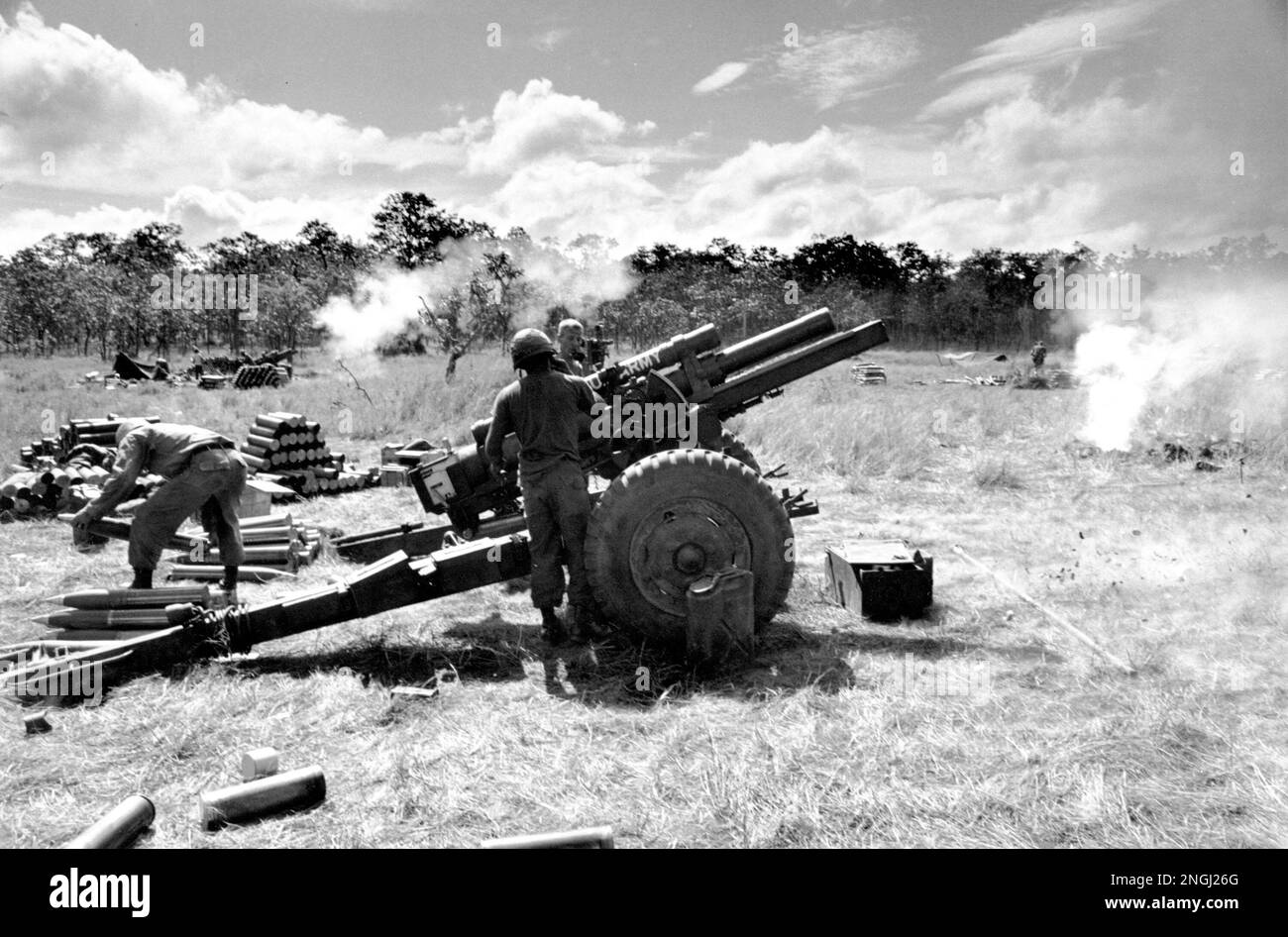 An American artilleryman picks up another 105mm shell as a 1st Cavalry ...