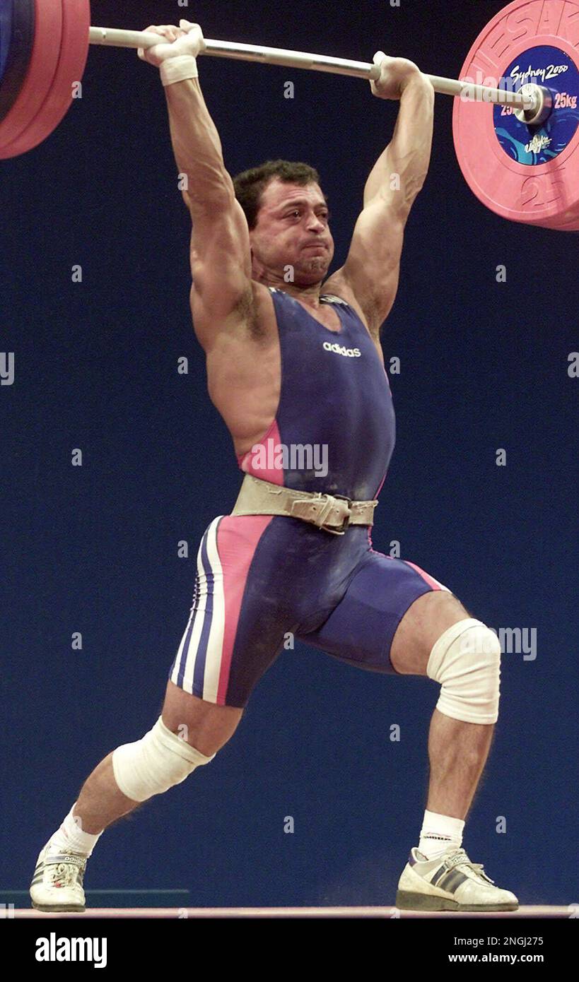 Sevdalin Angelov Minchev of Bulgaria completes a lift in the clean and ...