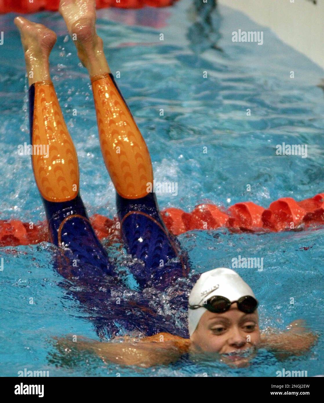 Dutch swimmer Inge de Bruijn swims over a lane marker after winning a ...