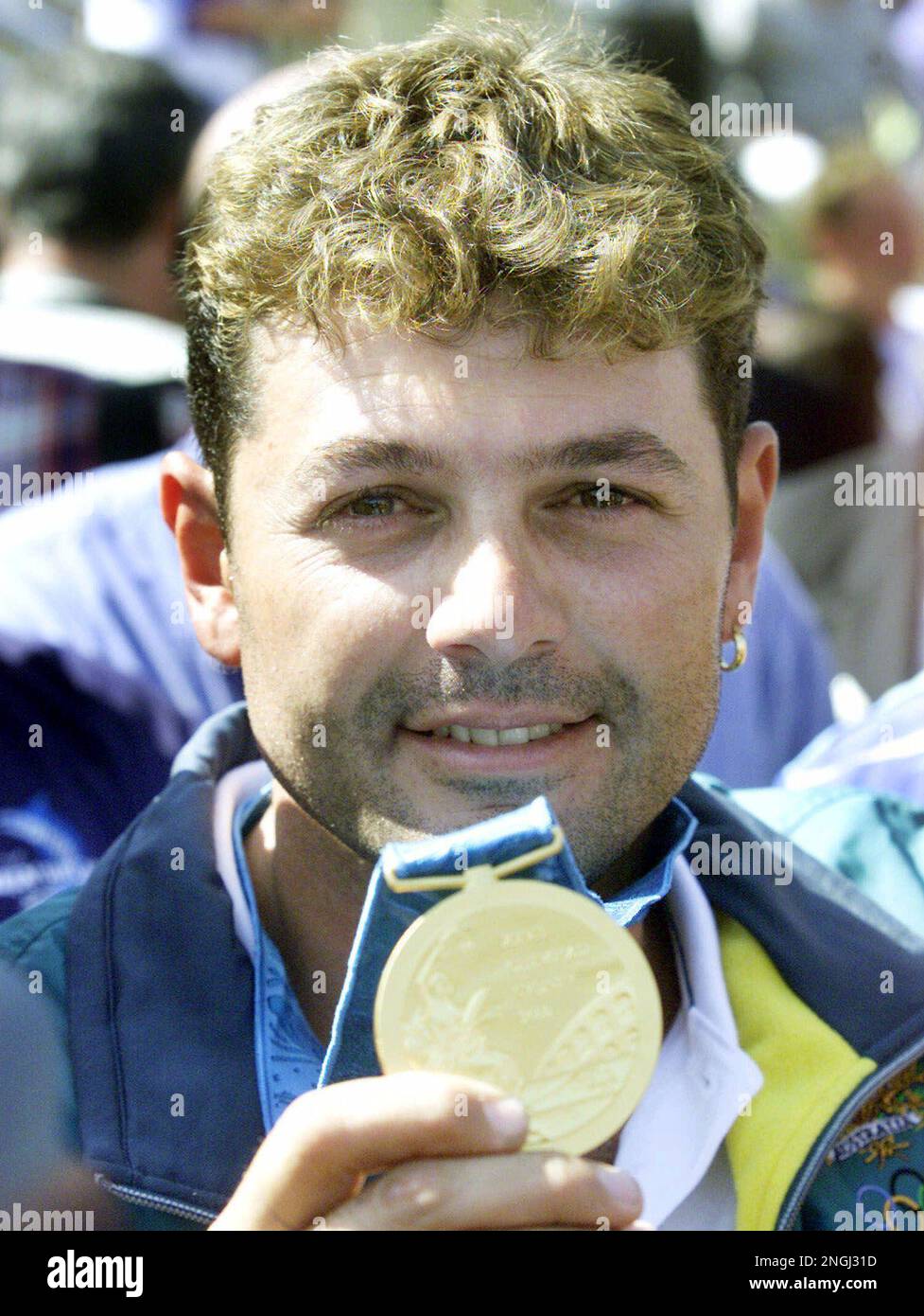 Australian shooter Michael Diamond displays the gold medal he won in ...