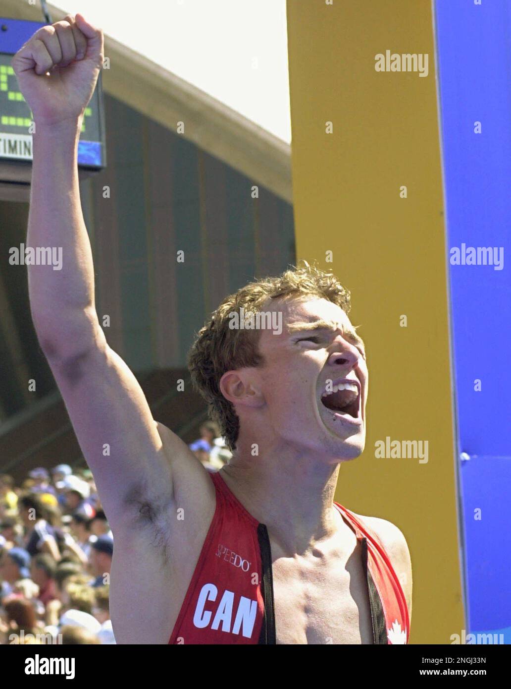 Simon Whitfield of Canada yells after crossing the finish line in the ...