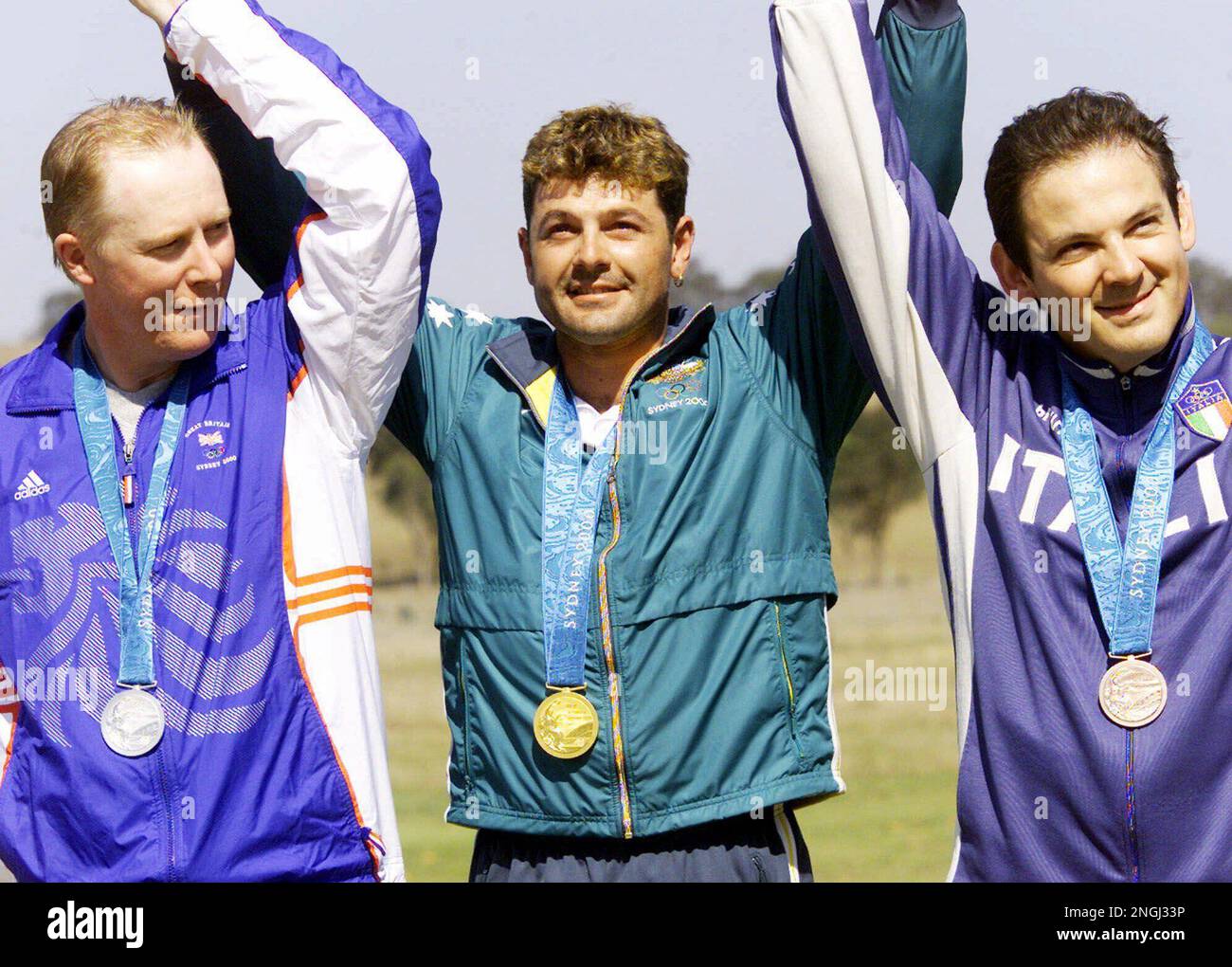 Australian shooter Michael Diamond, center, celebrates on the podium ...