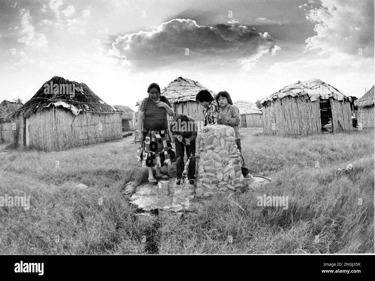 This is a 1980 photo of Kickapoo Indians gathering around a spigot in ...