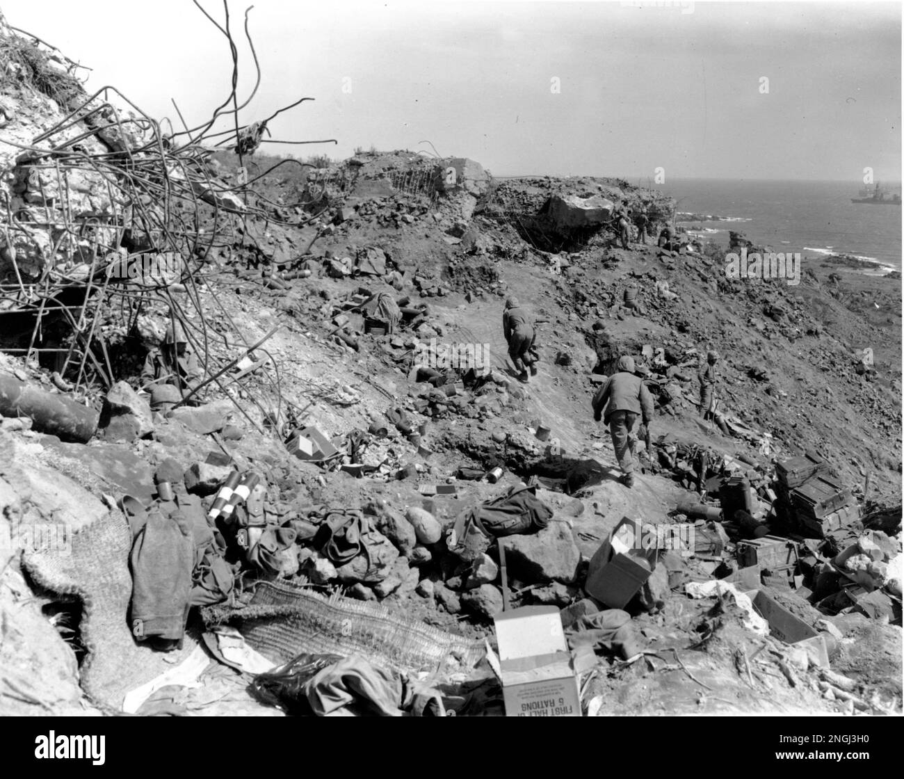 Two U.S. Marines crouch low and dash for cover to escape Japanese ...