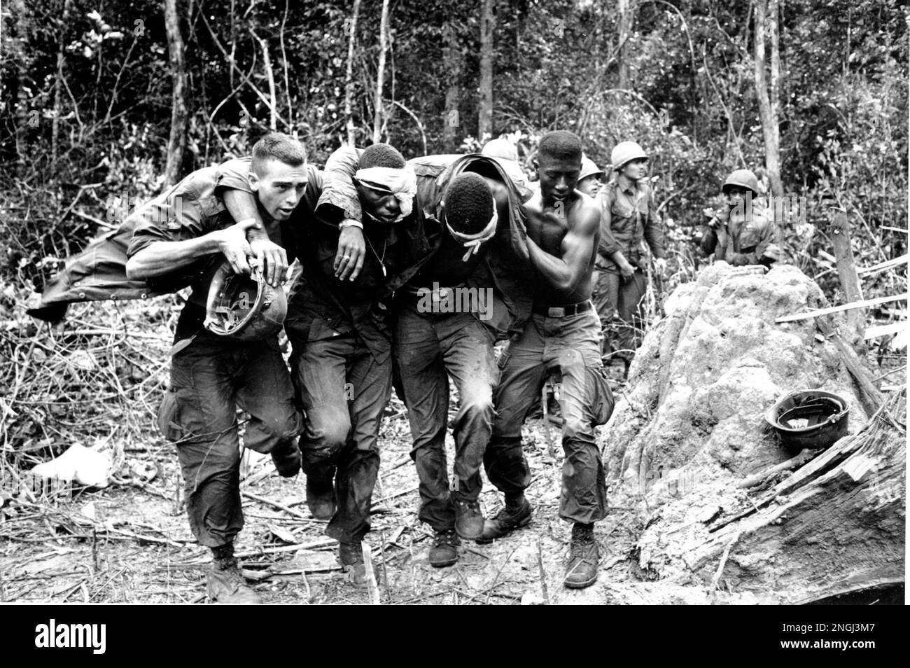 Wounded U.S. paratroopers are helped by fellow soldiers to a medical ...