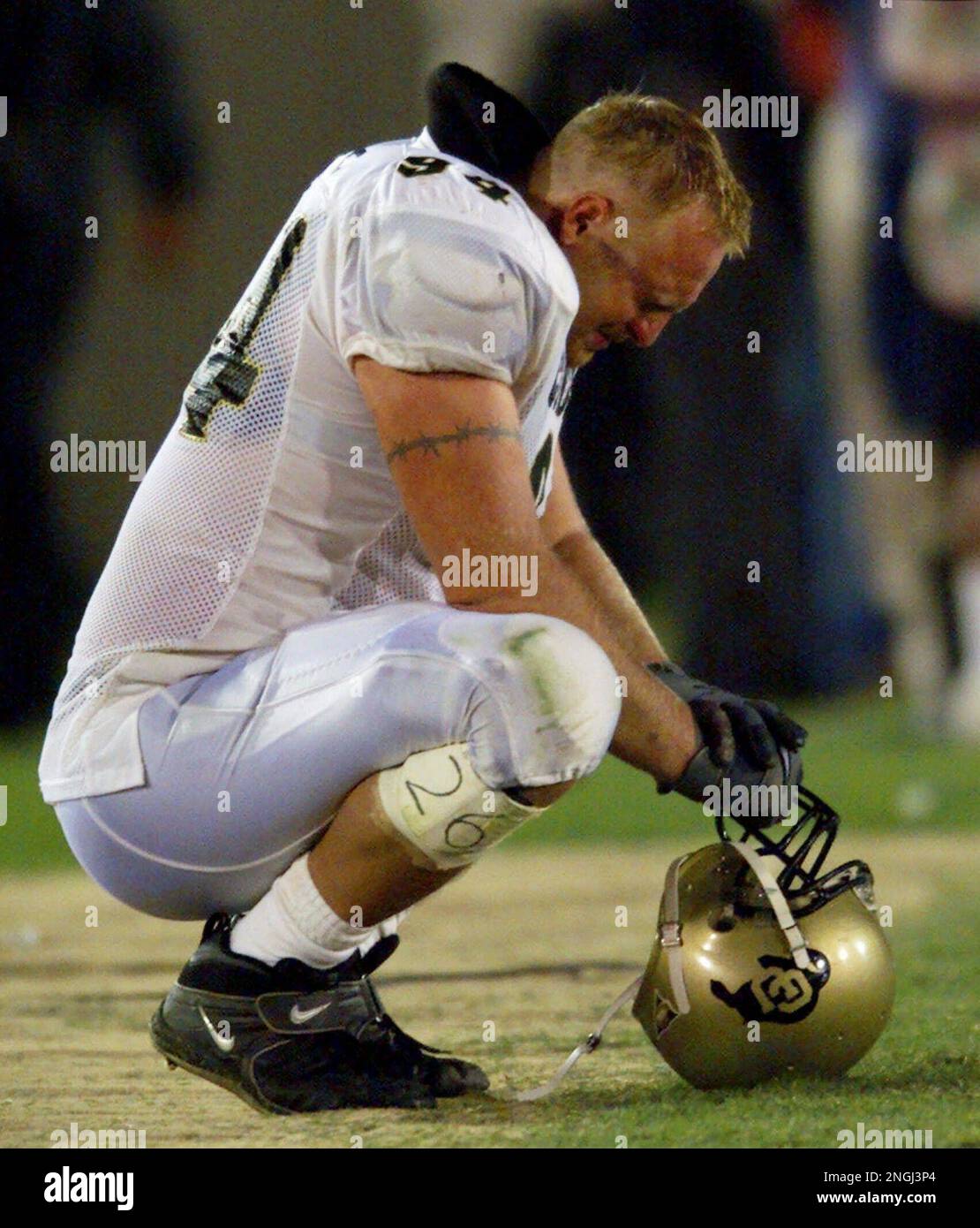University of Colorado defensive tackle Sean Jarne (94) is overcome ...