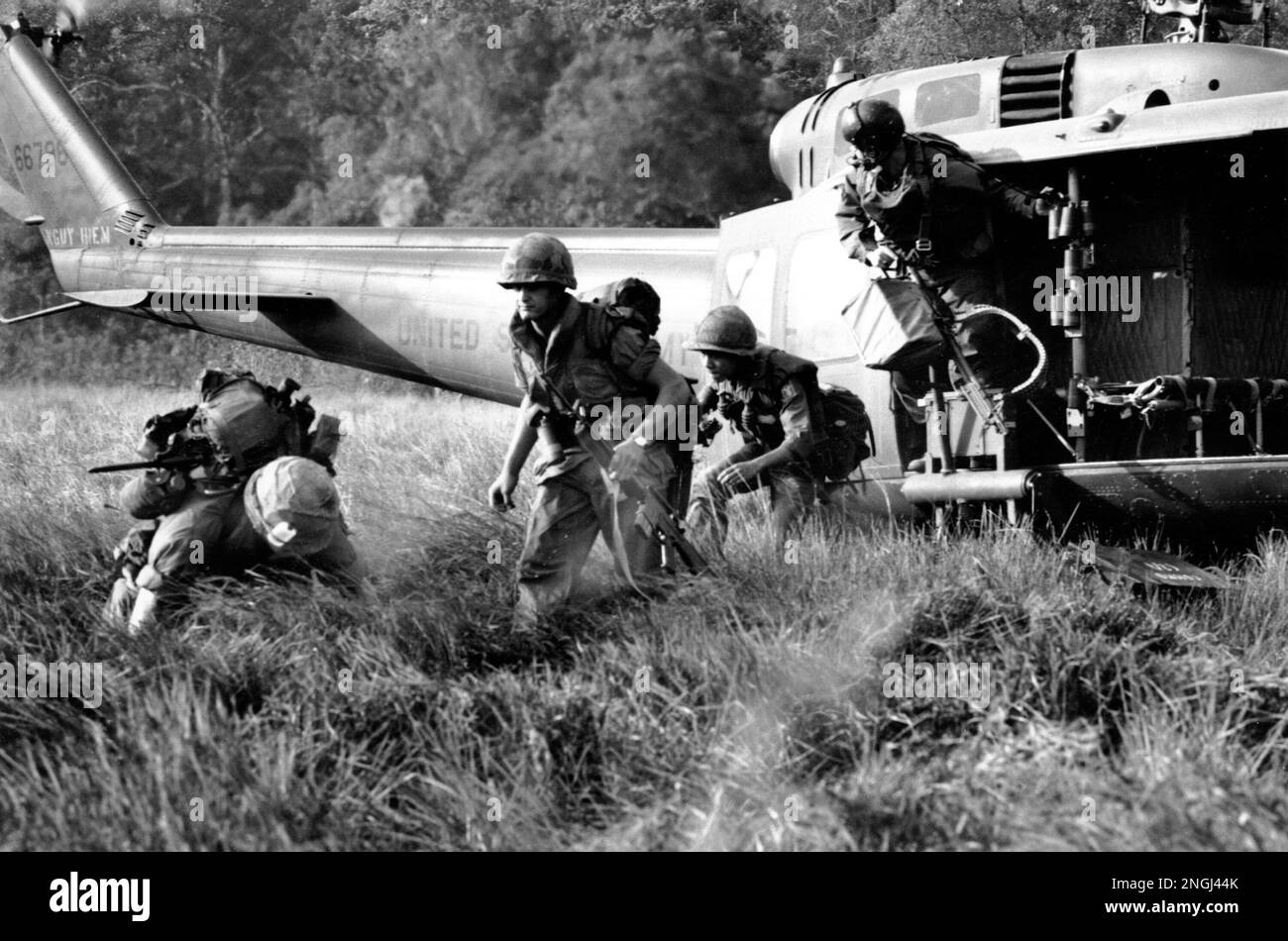 Troops of the U.S. 196th Light Infantry Brigade leap from a helicopter ...
