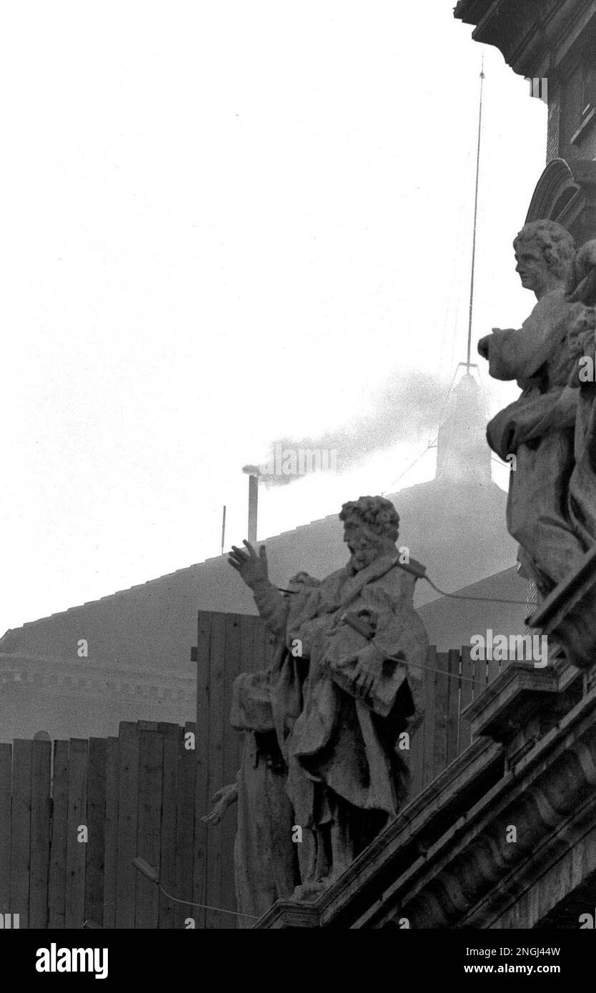 White smoke billows around the chimney atop the Sistine Chapel evening ...
