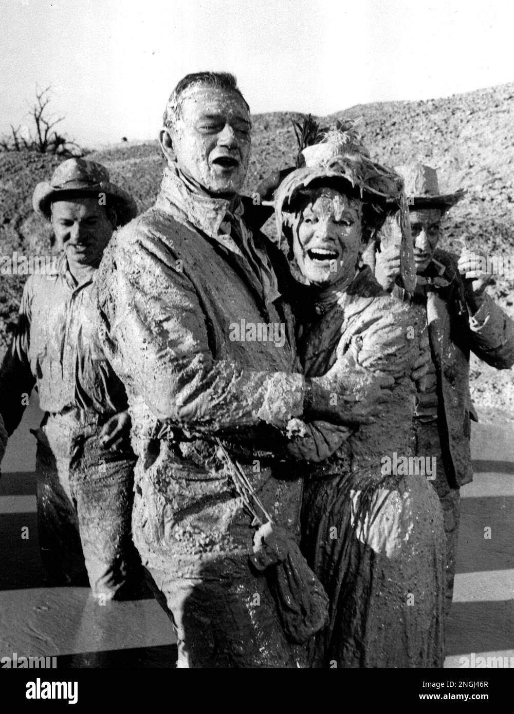 John Wayne and Maureen O'Hara get a laugh out of their muddied state on location in Arizona for ...