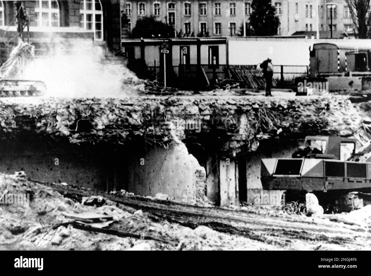 East Berlin workers with heavy equipment are ripping the remnants of ...