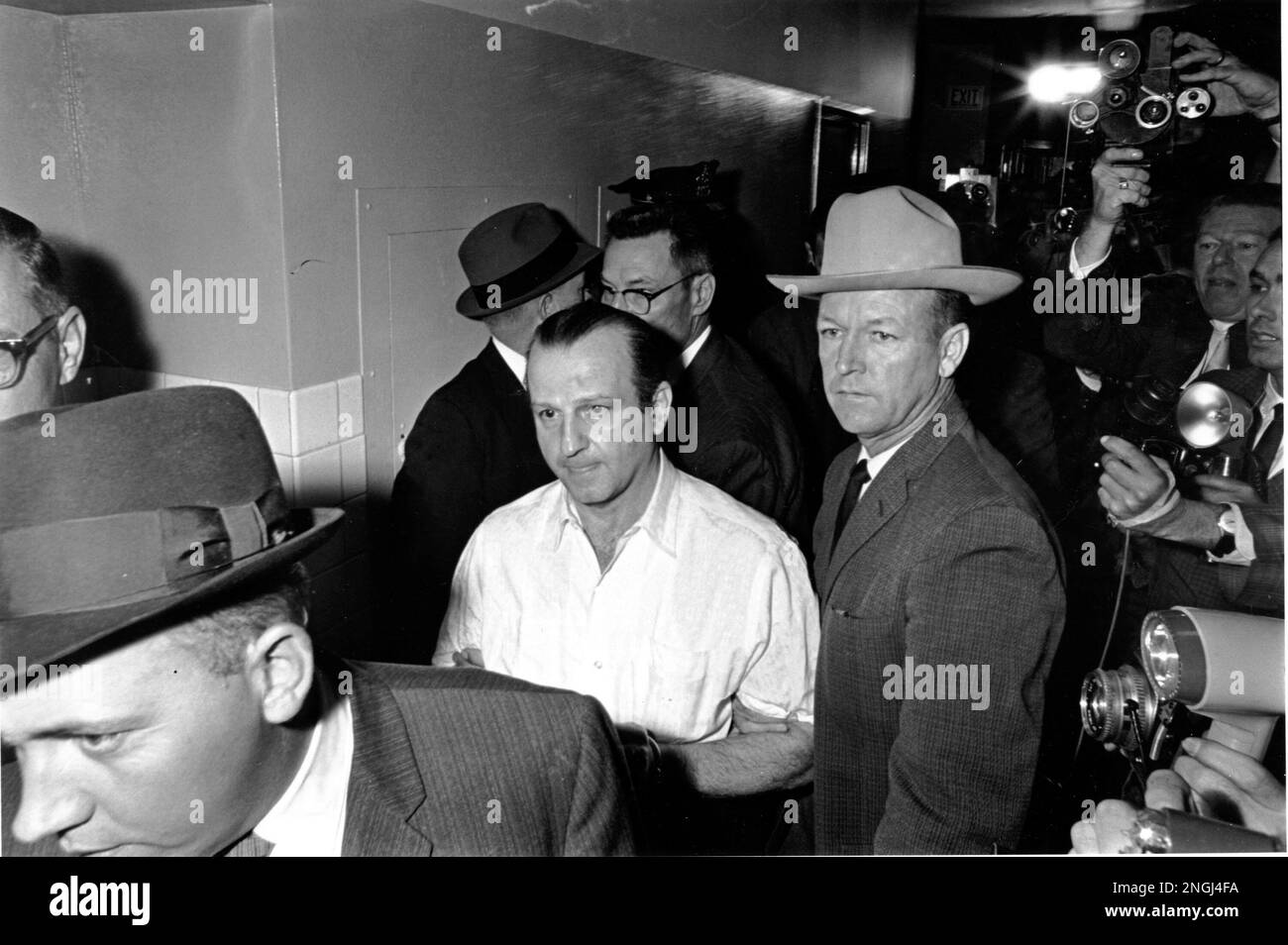 Nightclub owner Jack Ruby is led through the Dallas city jail on his ...