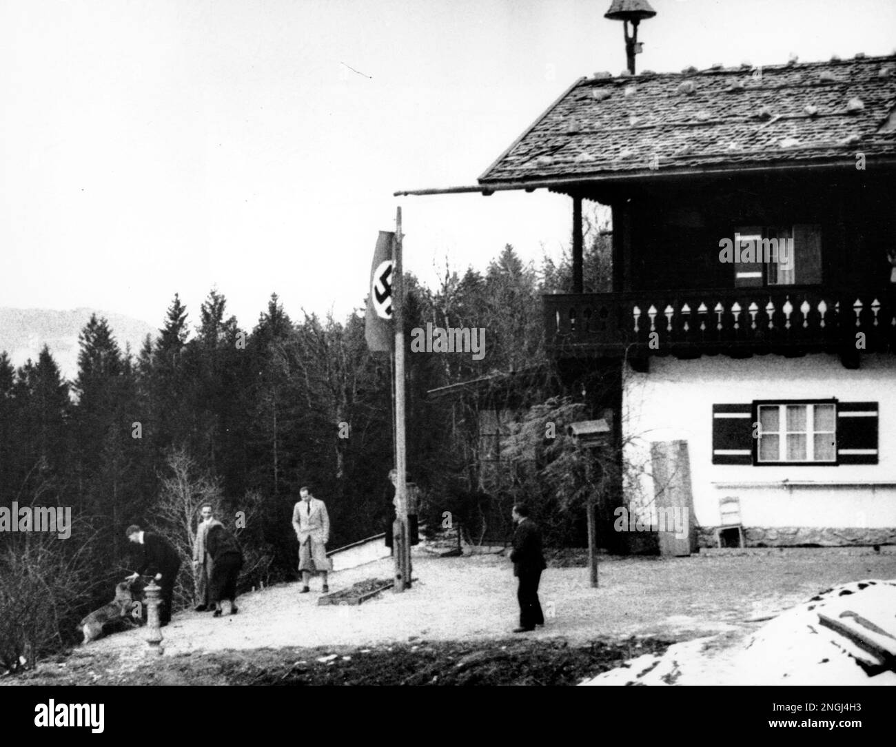 German chancellor Adolf Hitler pets his dog, left, at his mountain-top ...