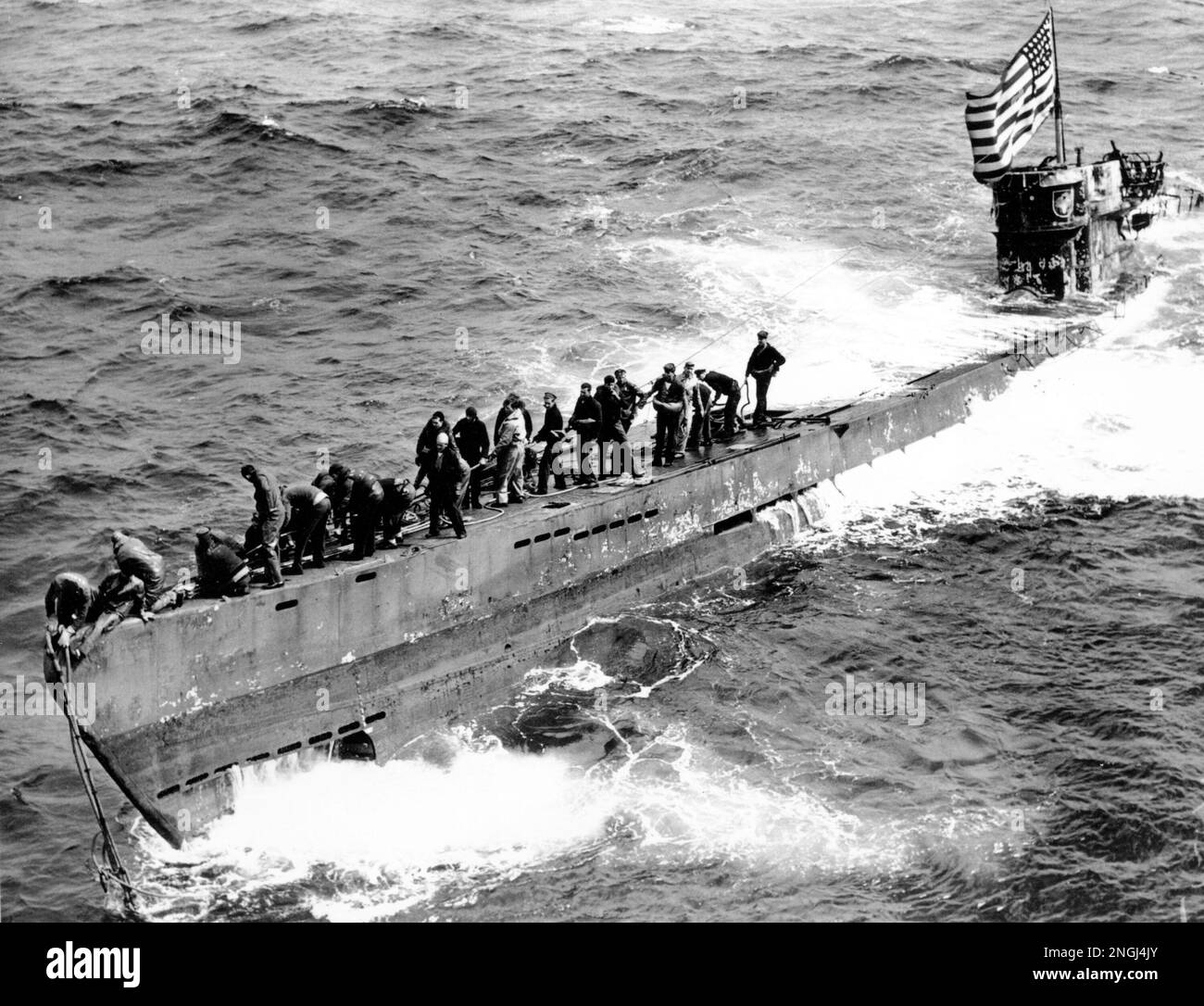 In this image provided by the U.S. Navy, the American flag flies from ...