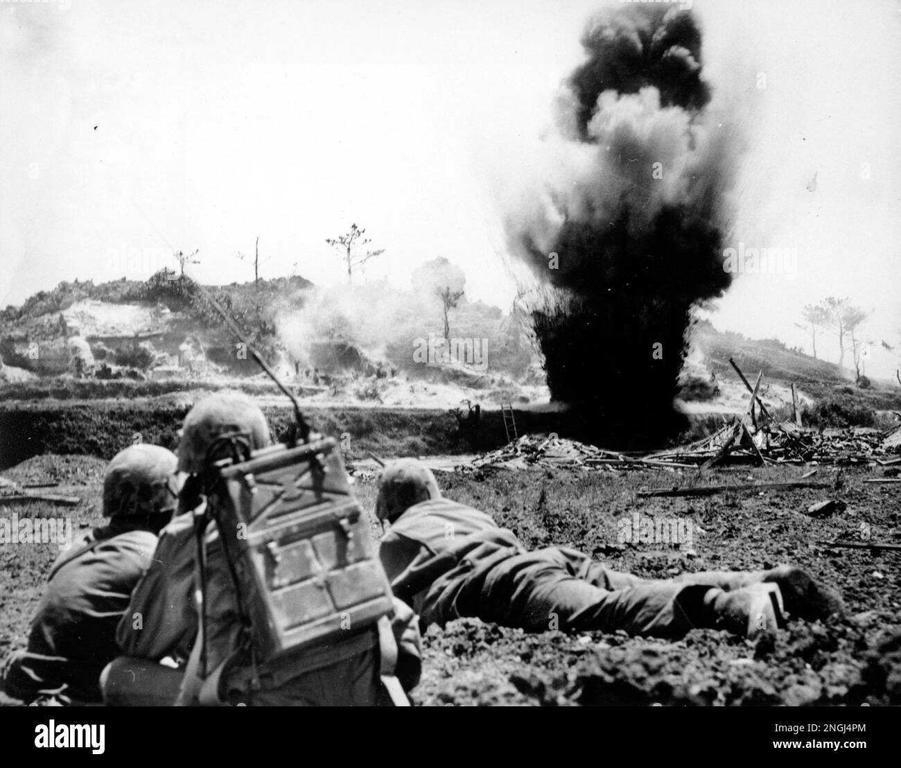 A dynamite blast showers debris high into the air as the U.S. Marines ...