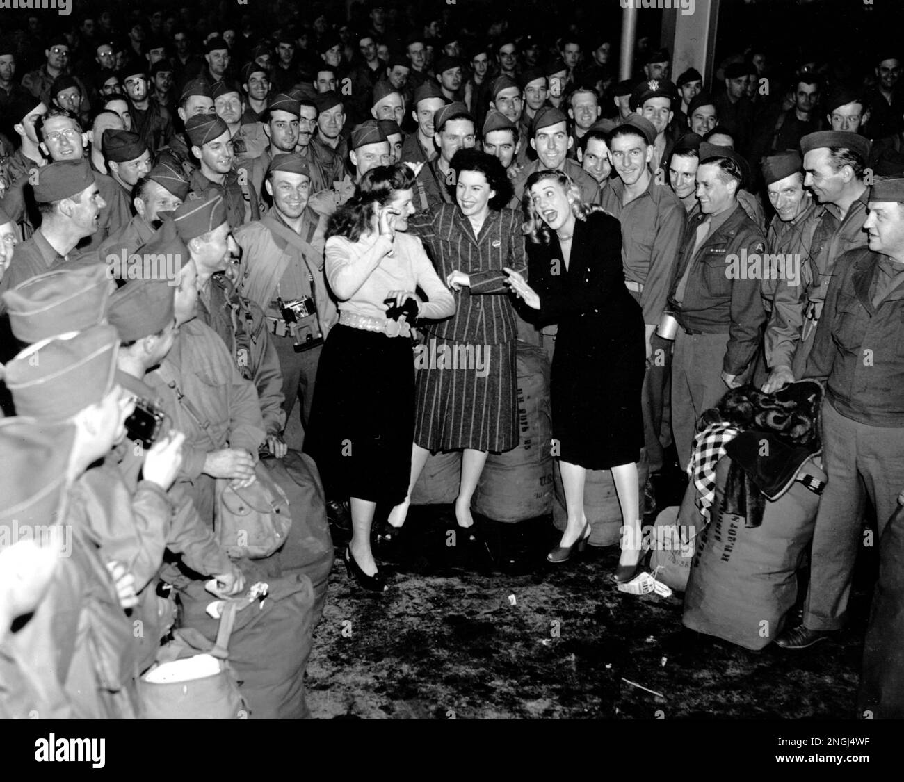 The Andrews Sisters sing for GI's returning from World War II in Europe after they disembarked ...