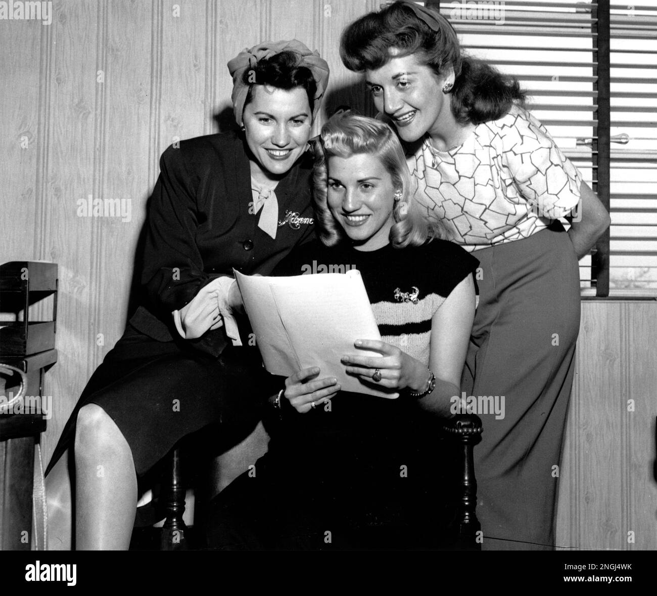 The Andrews Sisters, radio and stage entertainers, go over a song ...