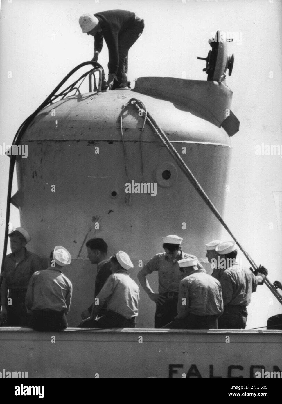 The crew of the submarine rescue ship Falcon conditions a newly ...