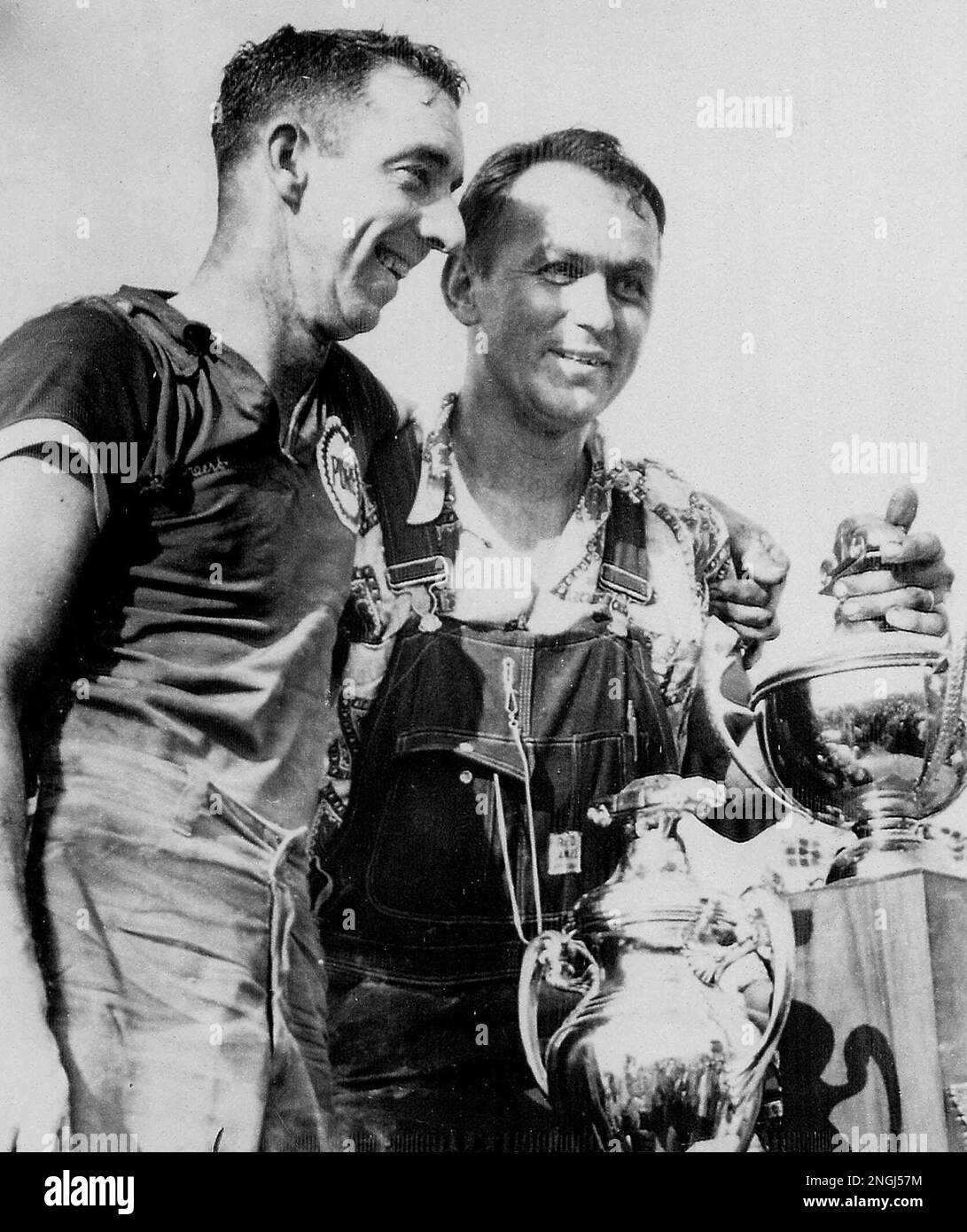 Herb Thomas, left, and his mechanic "Smokey Yunick, looks at the trophy ...