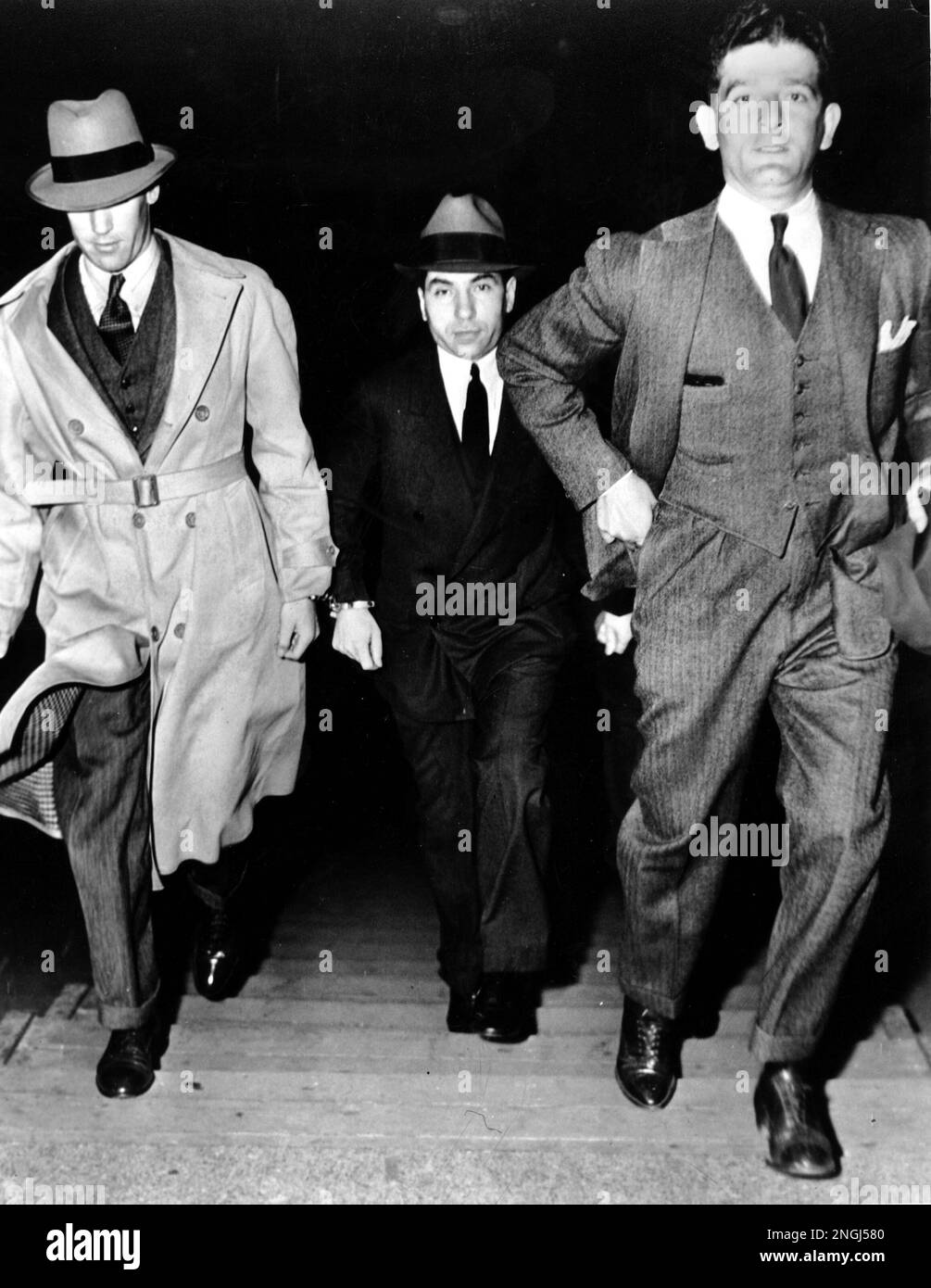 Charles "Lucky" Luciano, center, is escorted into court by two detectives on June 18, 1936 ...