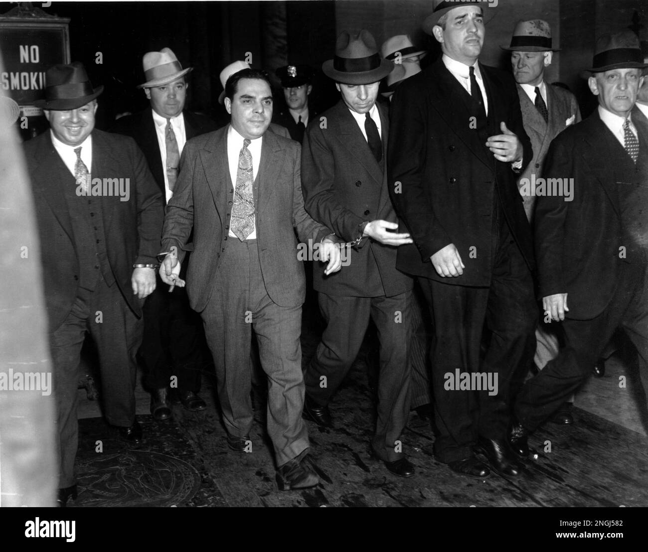 Charles "Lucky" Luciano convicted of vice charges, is leaving court on June 18, 1936 handcuffed ...