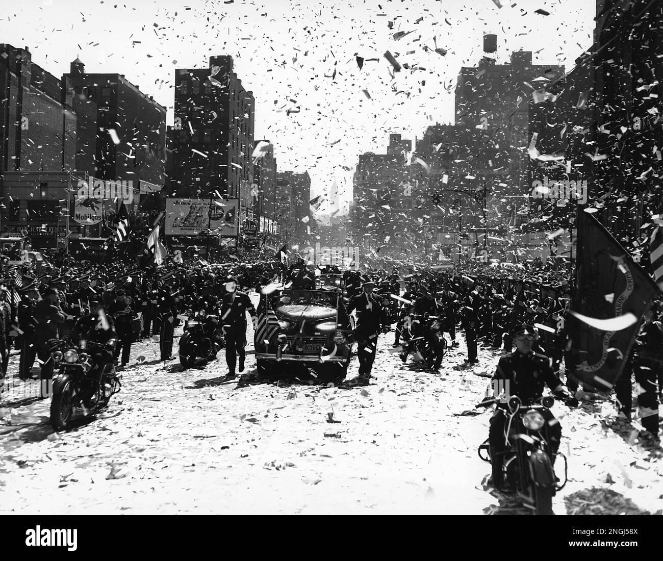 Paper continues to shower on Gen. Douglas MacArthur as he stands in an ...