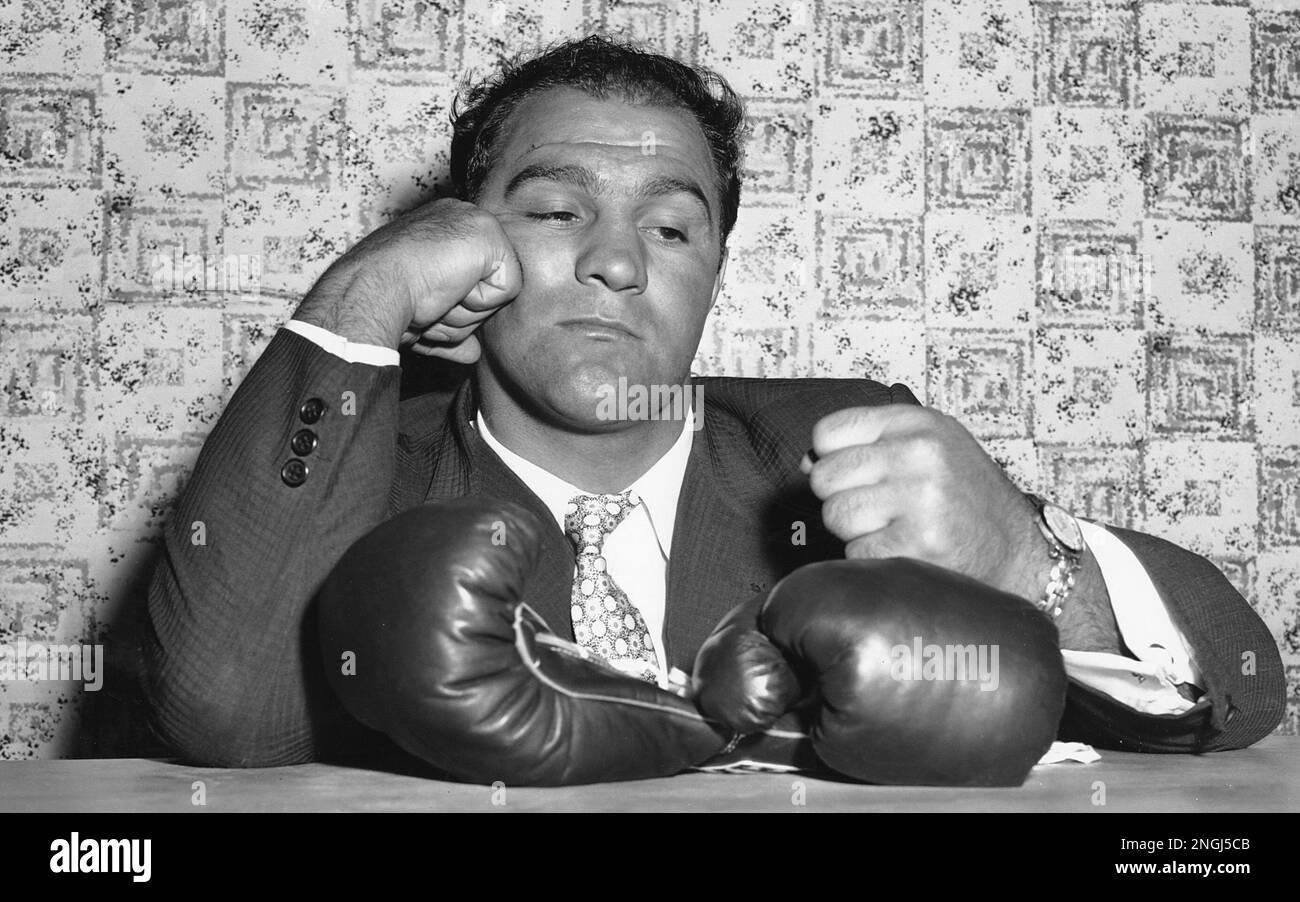 World heavyweight champion Rocky Marciano rests his head and hand at a ...