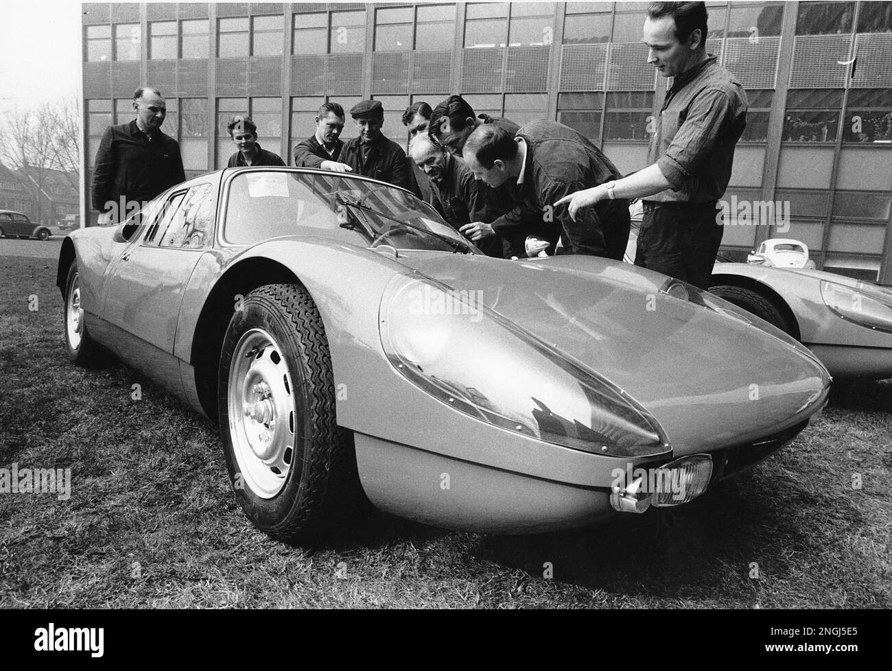 A group of mechanics examine the new Porsche Gran Turismo Type 904 ...