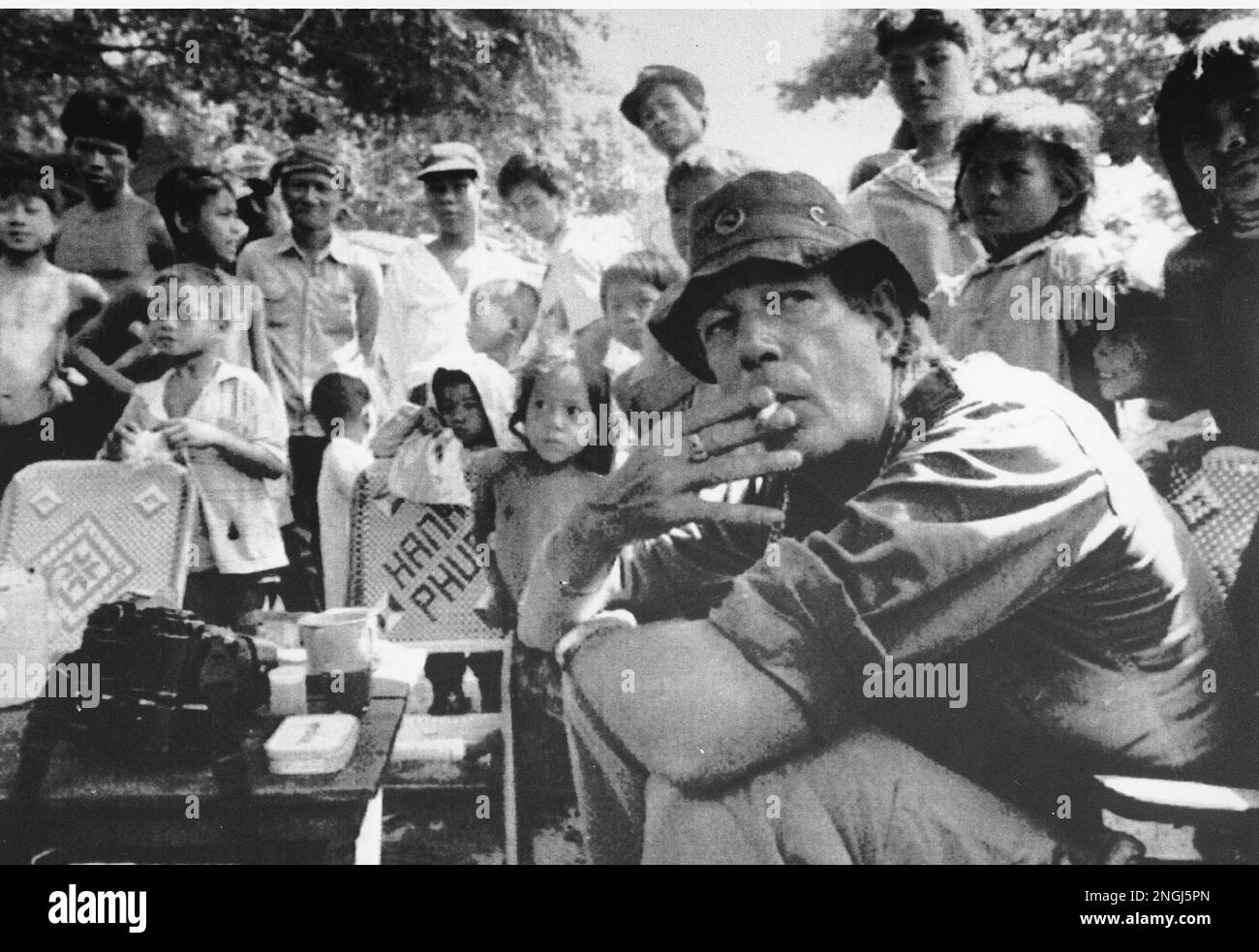 British photographer Tim Page is surrounded by Cambodian children at a ...