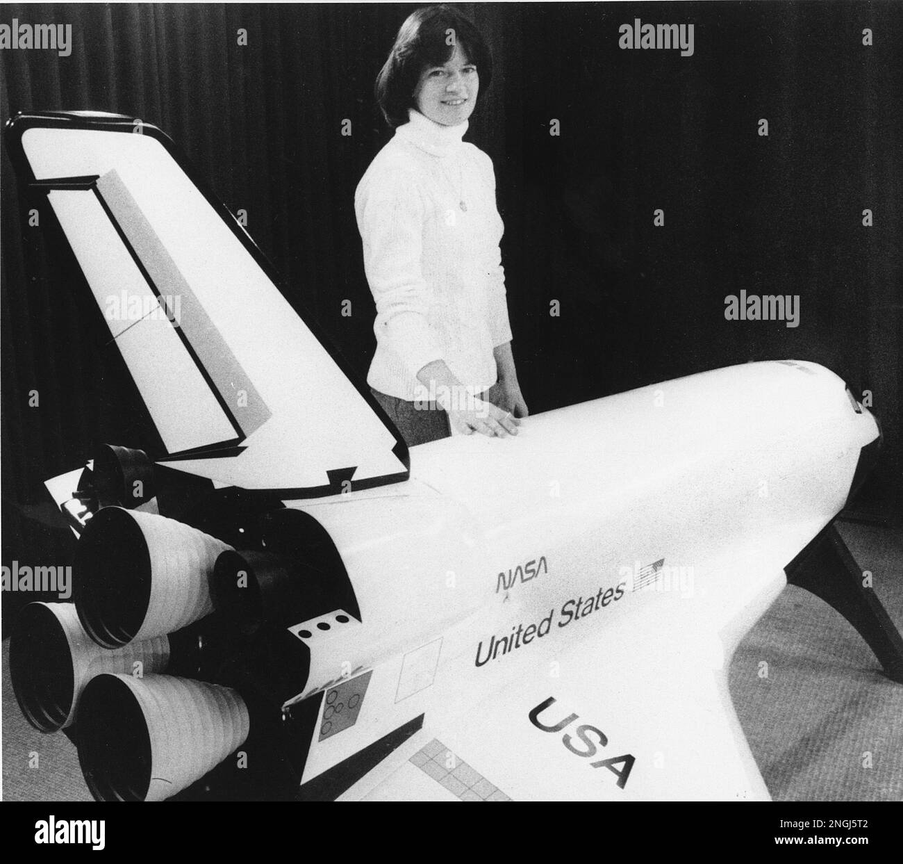 This is a 1983 photo of Sally Kristin Ride posing behind a model of the ...