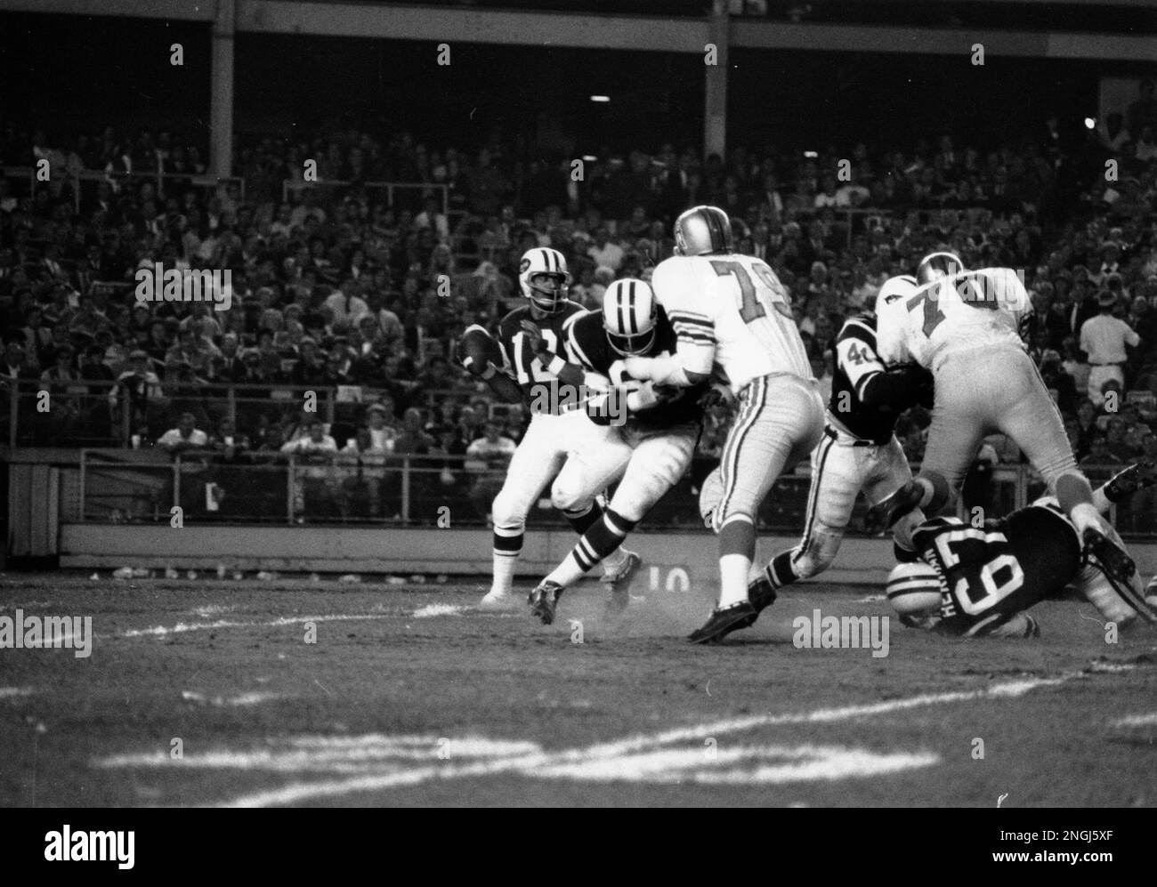 Quarterback Joe Namath (12) of the New York Jets fades back behind ...