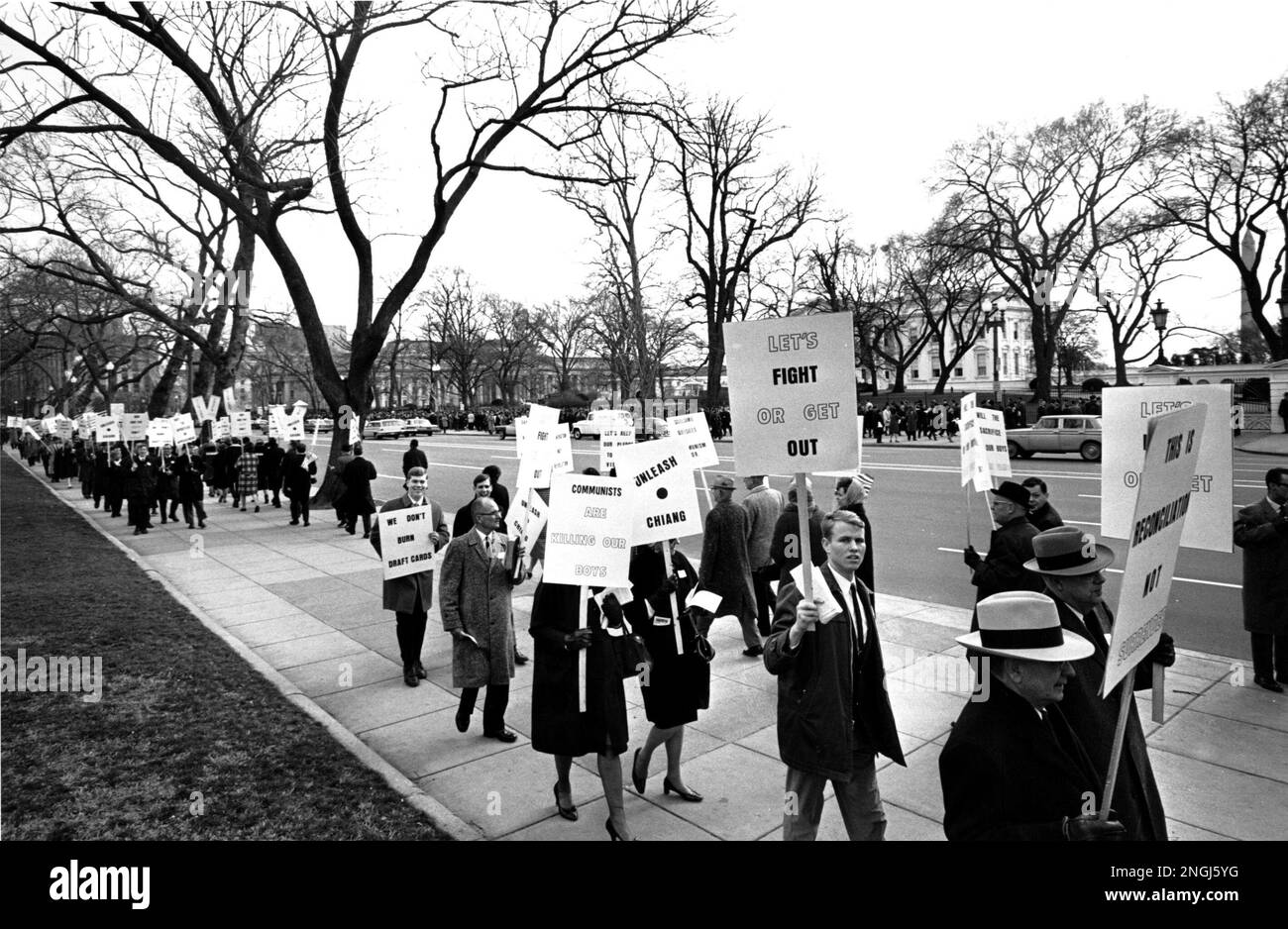 Two groups of demonstrators are seen walking on opposite sides of ...