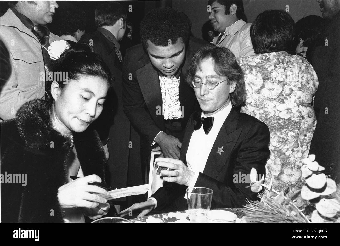 John Lennon and his wife, Yoko Ono, left, are shown with heavyweight boxer Muhammad Ali, center ...