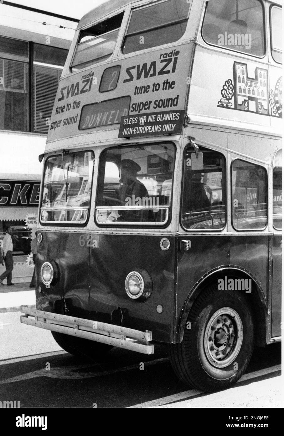 This is a photo of a doubledeck bus with a black driver and black ...