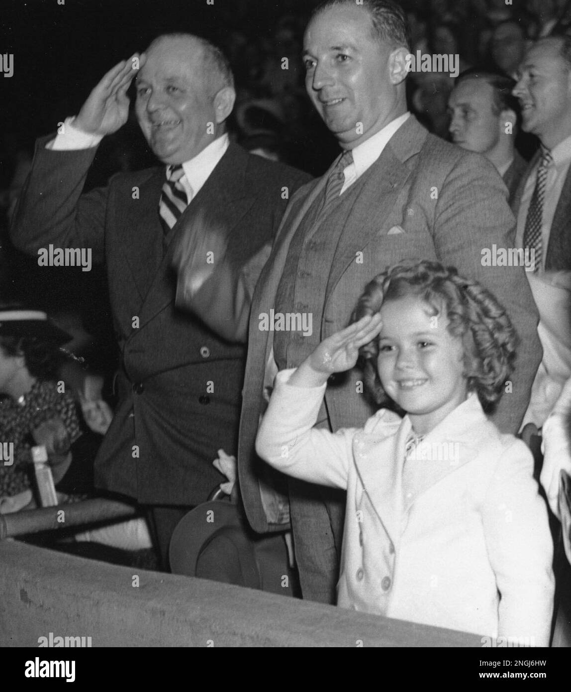 Child actress Shirley Temple salutes the colors as they pass her box at ...