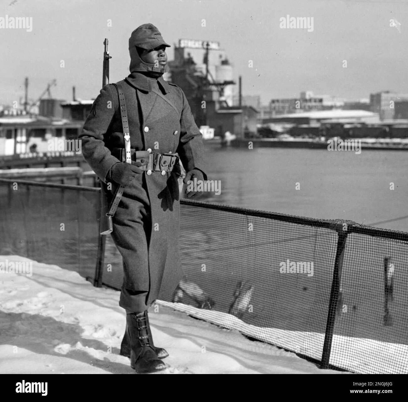 This is a regular Army sentry, bundled against the cold, as he walks ...