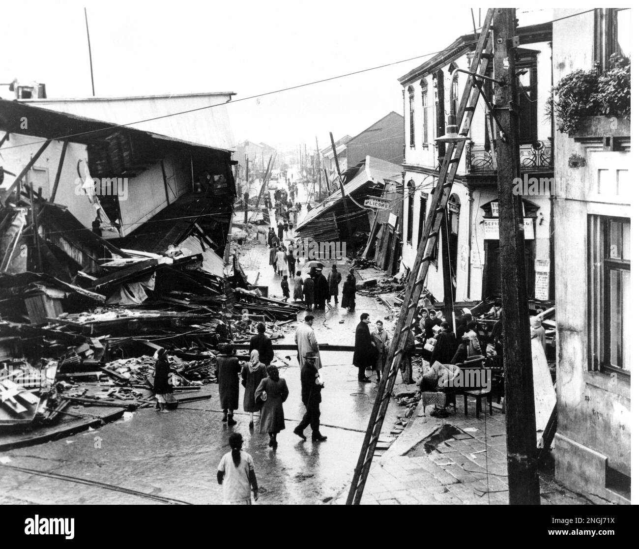 Residents of Valdivia, Chile look over wrecked buildings on May 31 ...