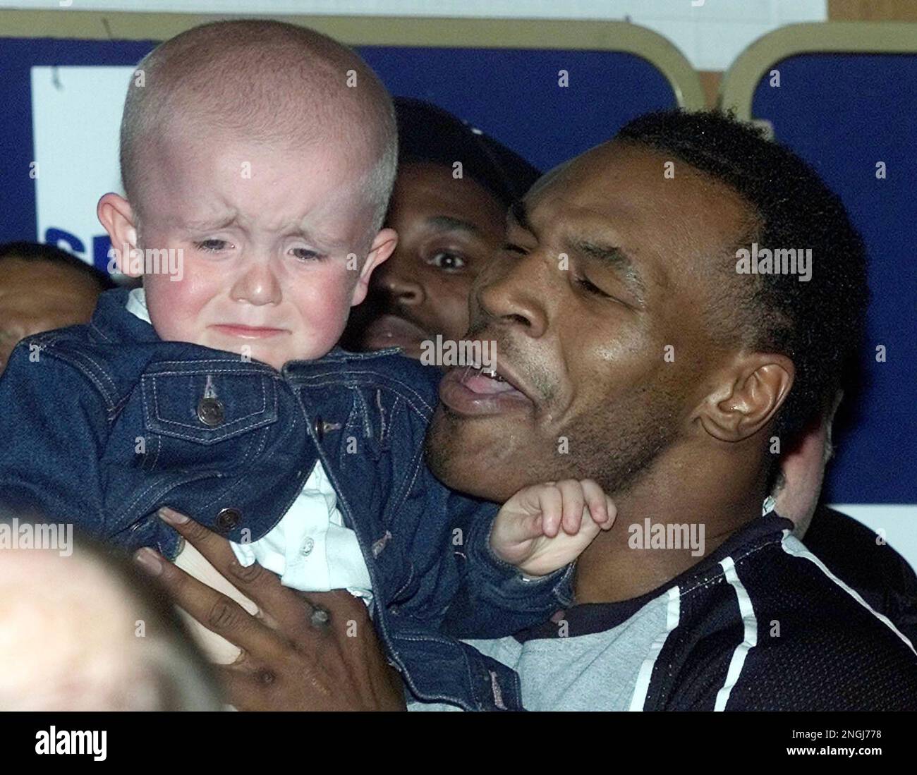 American heavyweight boxer Mike Tyson cuddles three-year-old Aiden ...