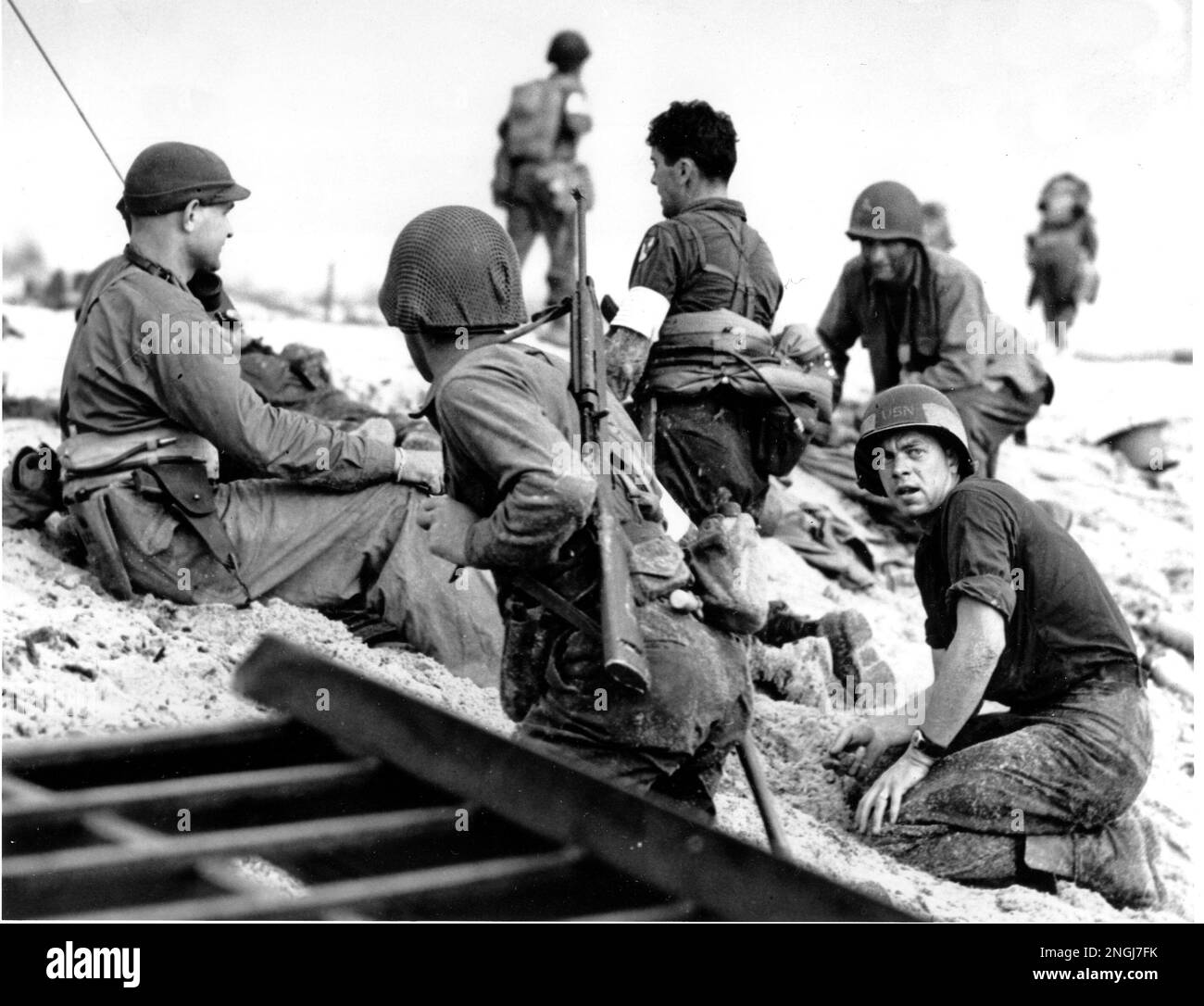 A first wave beach battalion Ducks lays low under the fire of Nazi guns on the beach of southern ...