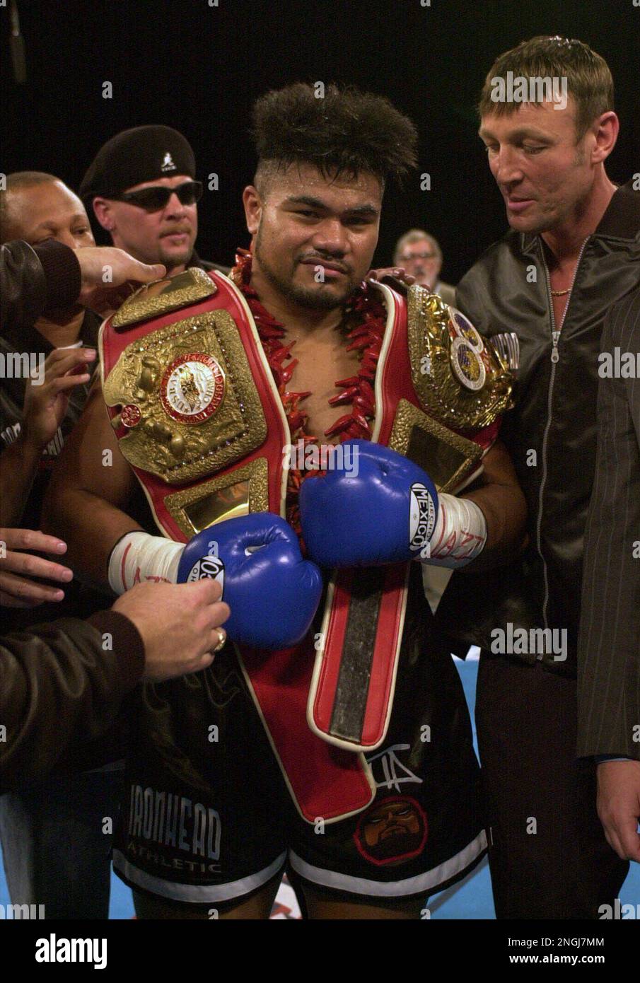 David Tua poses with his championship belts after knocking out Obed ...