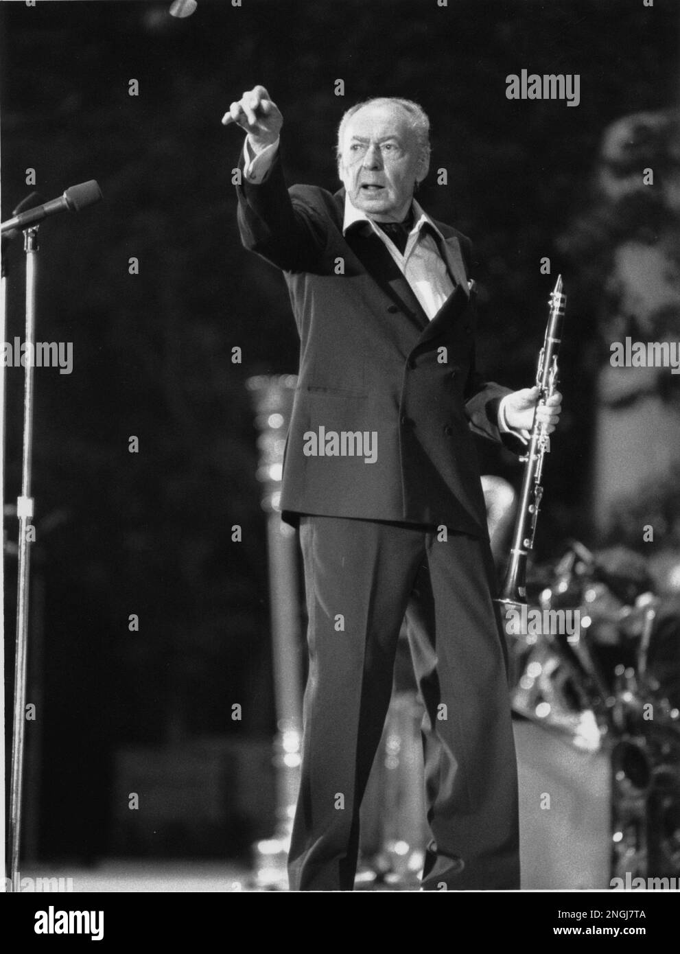 Musician Woody Herman conducts The Young Thundering Herd at a concert ...