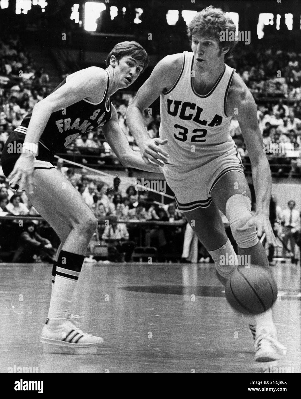 UCLA's Bill Walton dribbles around San Francisco's Eric Fernston in the ...